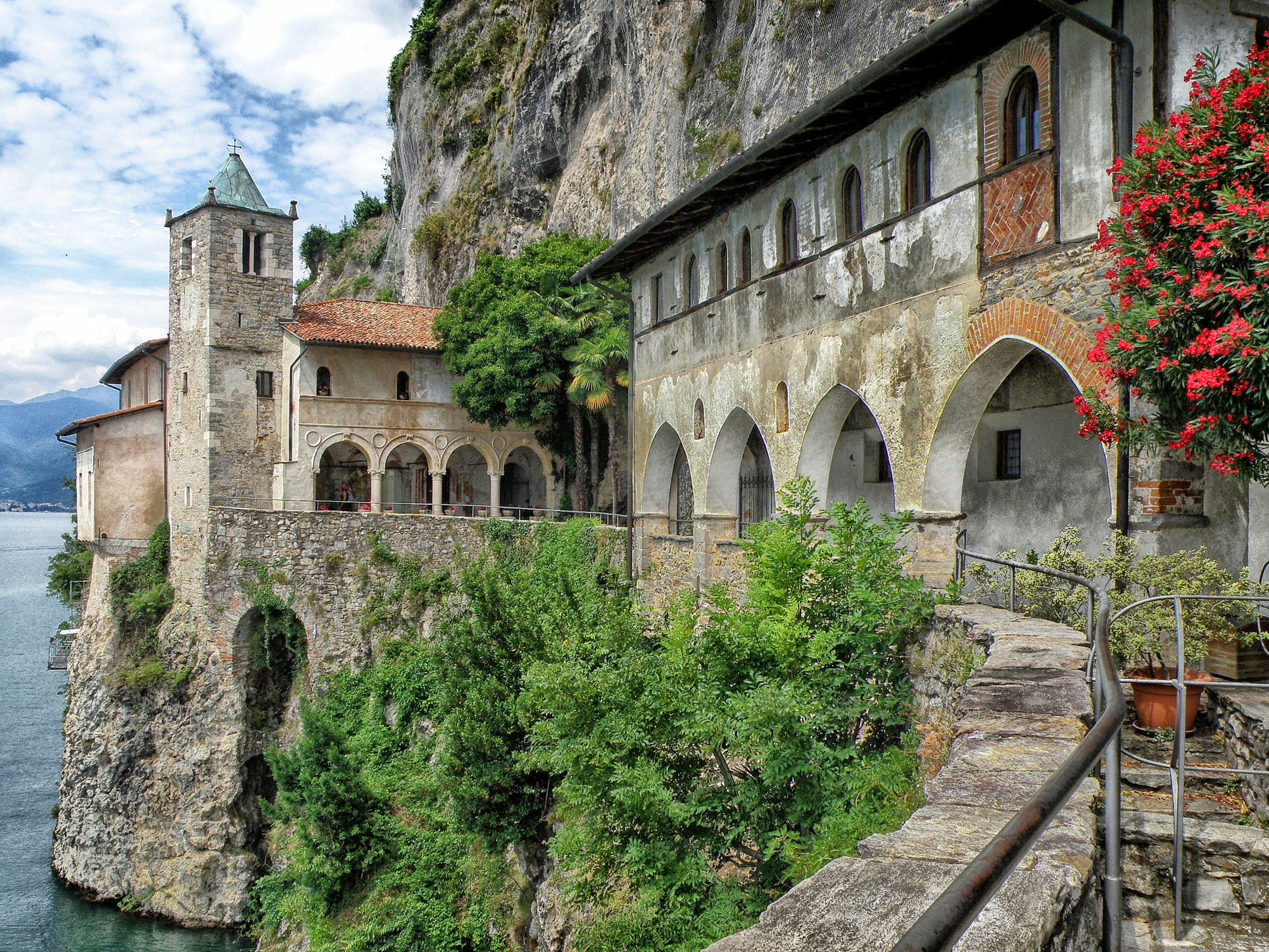 Passage at facade of santa caterina del sasso monastery on rock, italy ...