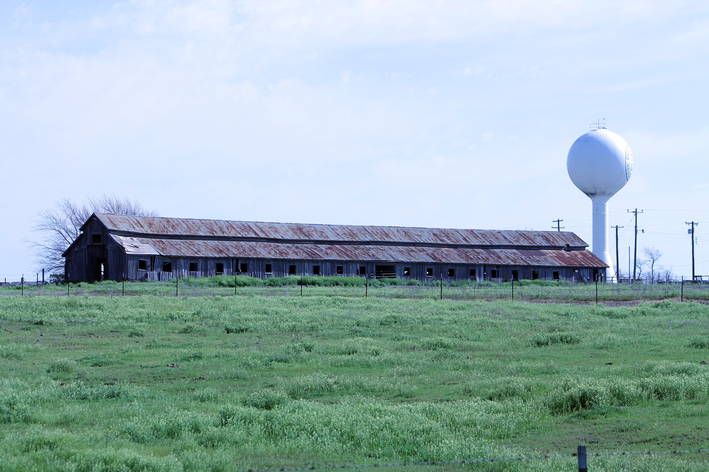 Old long farm building on green meadow, usa, oklahoma, fort reno free ...