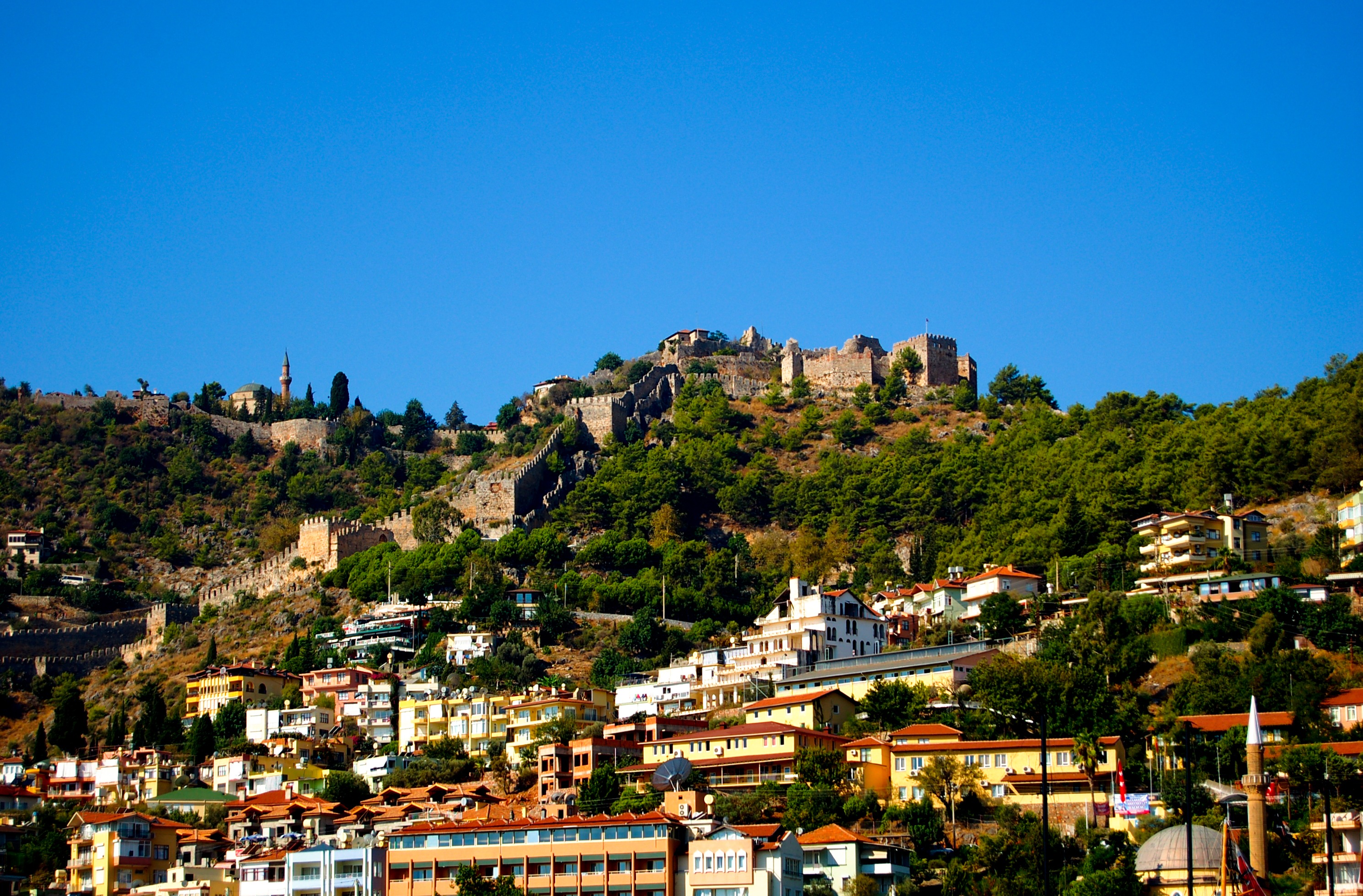 City on a hill under a blue sky free image download