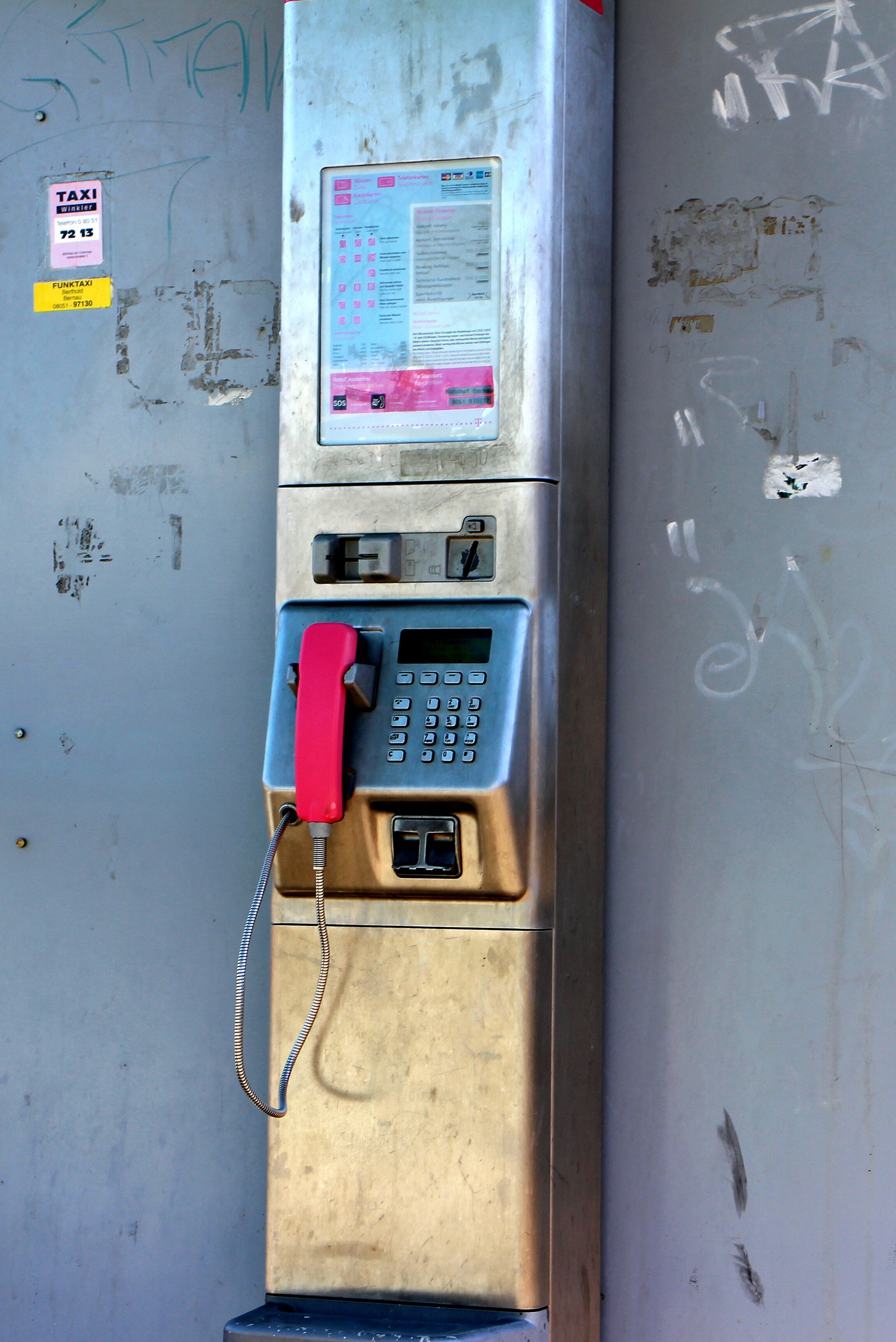 Public telephone in an unfavorable light free image download
