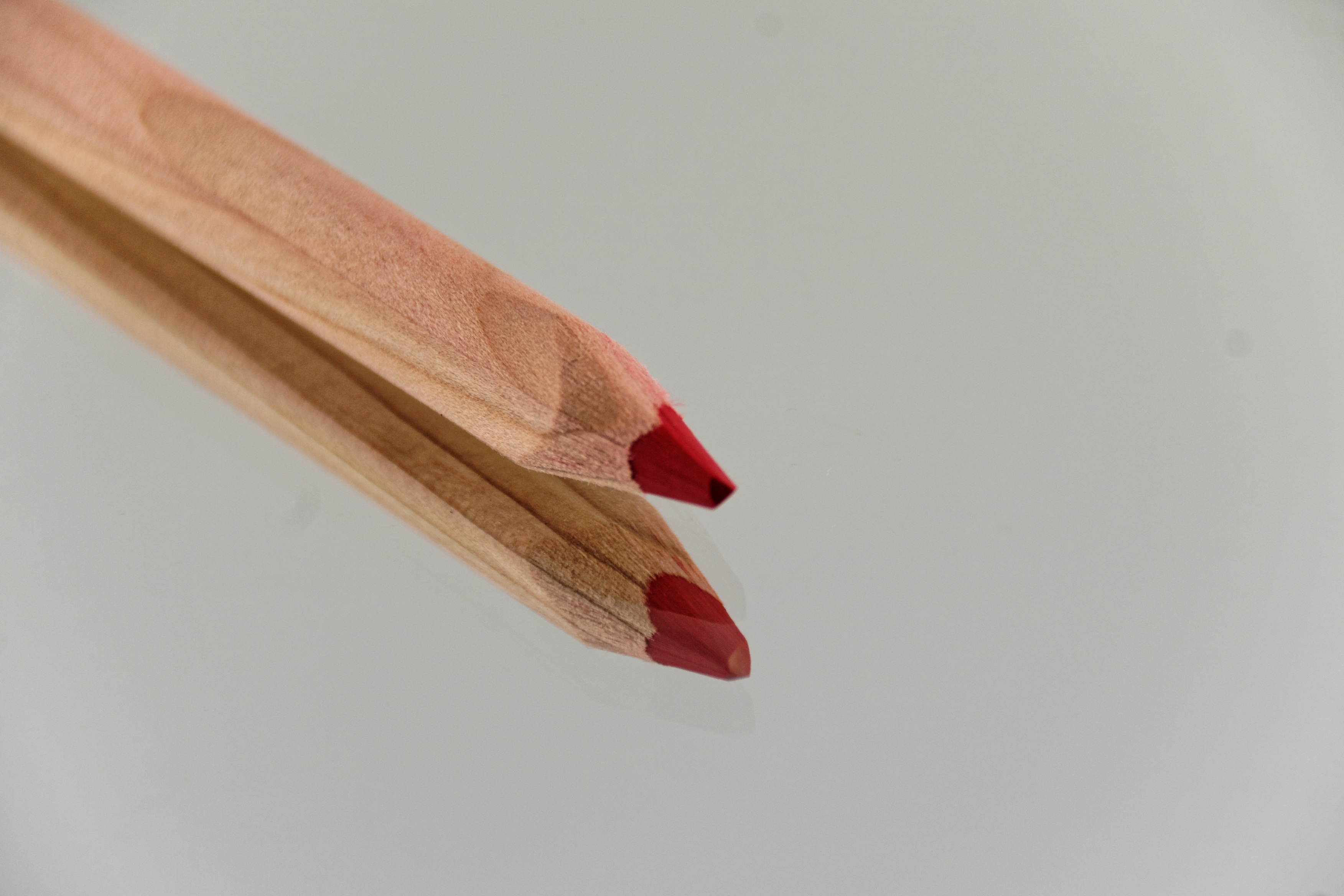 Sharpened edge of pencil with red core on the mirror surface free image ...