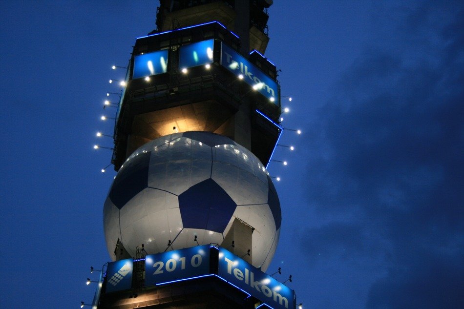 Soccer ball as part of a television tower at night free image download