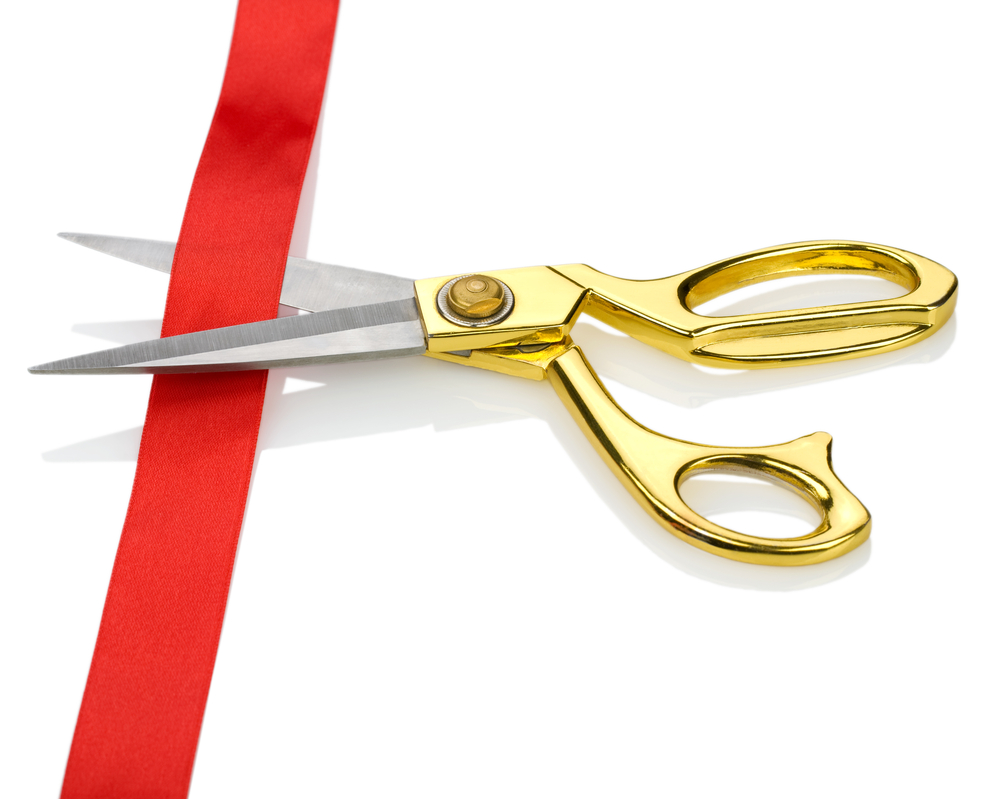 Scissors with golden handles near the red ribbon free image download