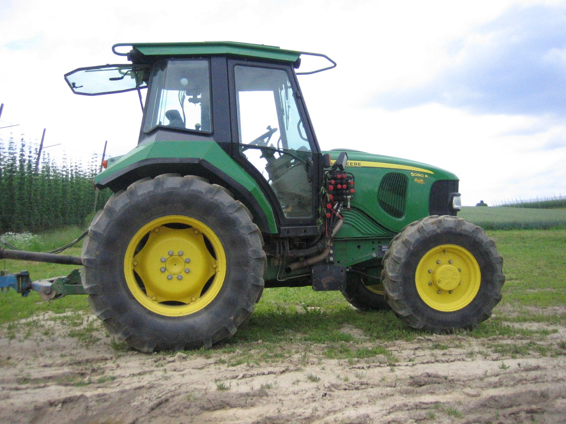 Green tractor in countryside free image download