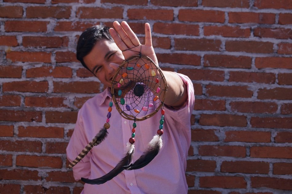 Dream catcher, handmade willow hoop with feathers in hand of smiling ...