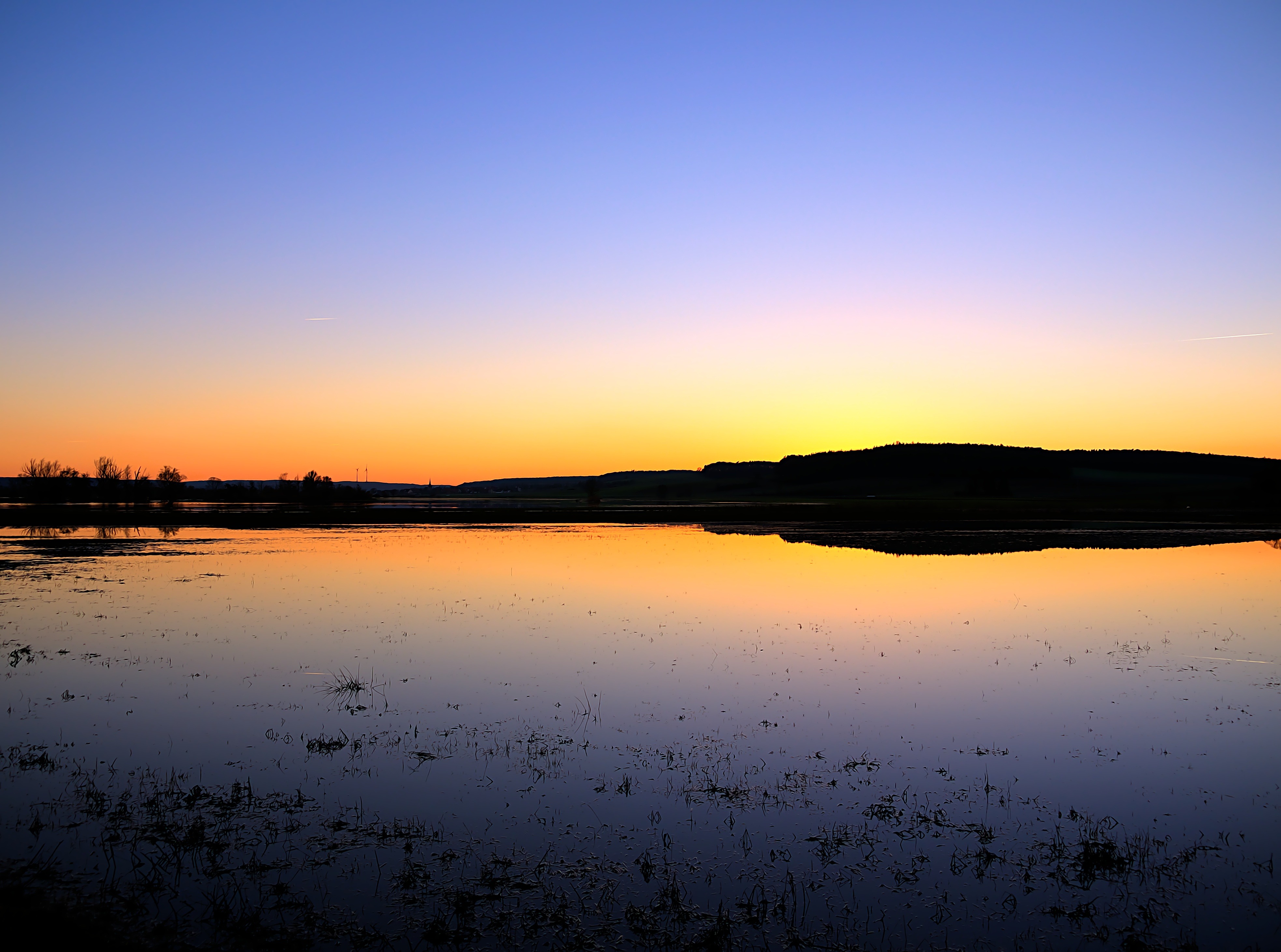 Blue sky and blue water and blazing sun sunset free image download