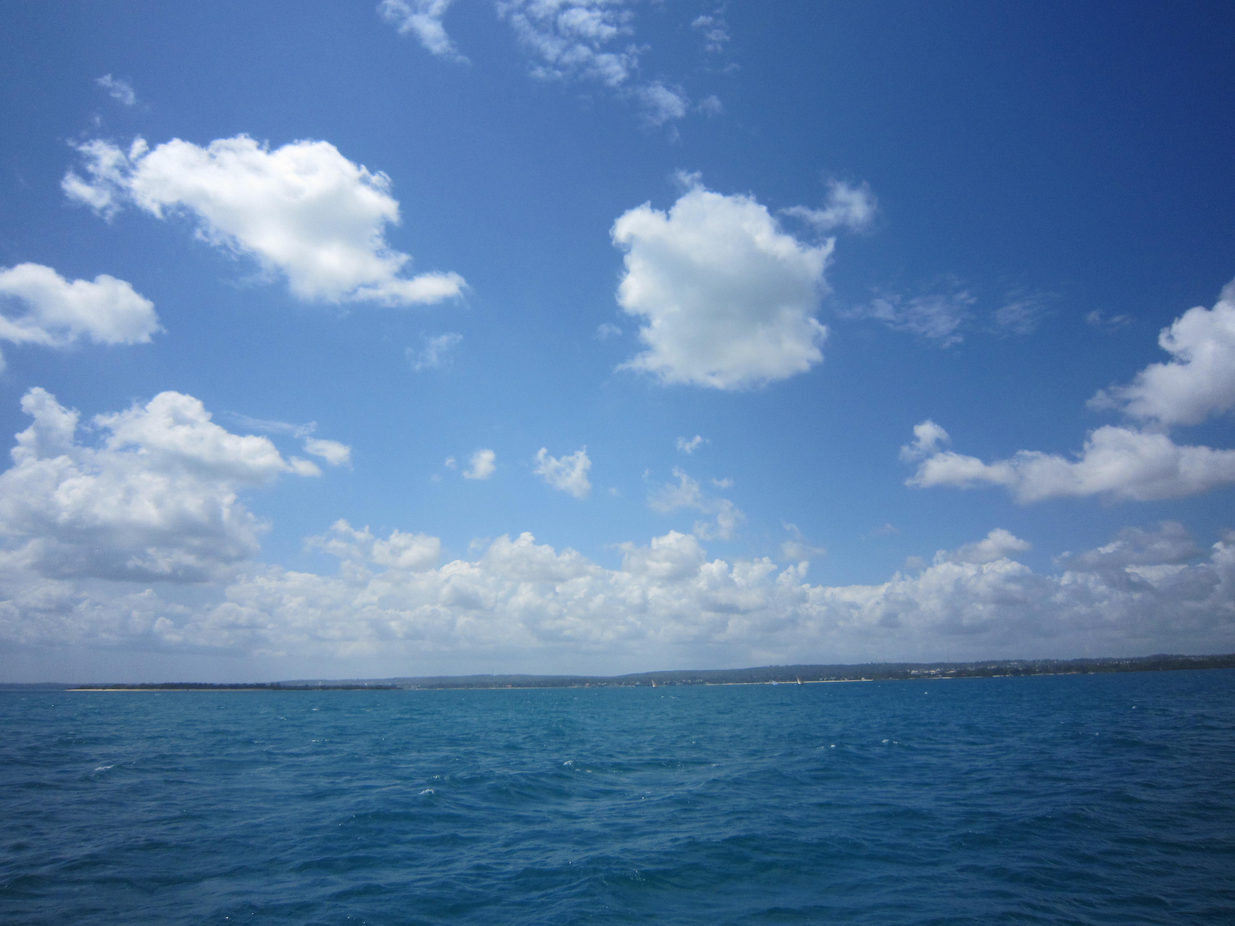 Beautiful calm sea under blue sky with white clouds in Zanzibar, Africa ...