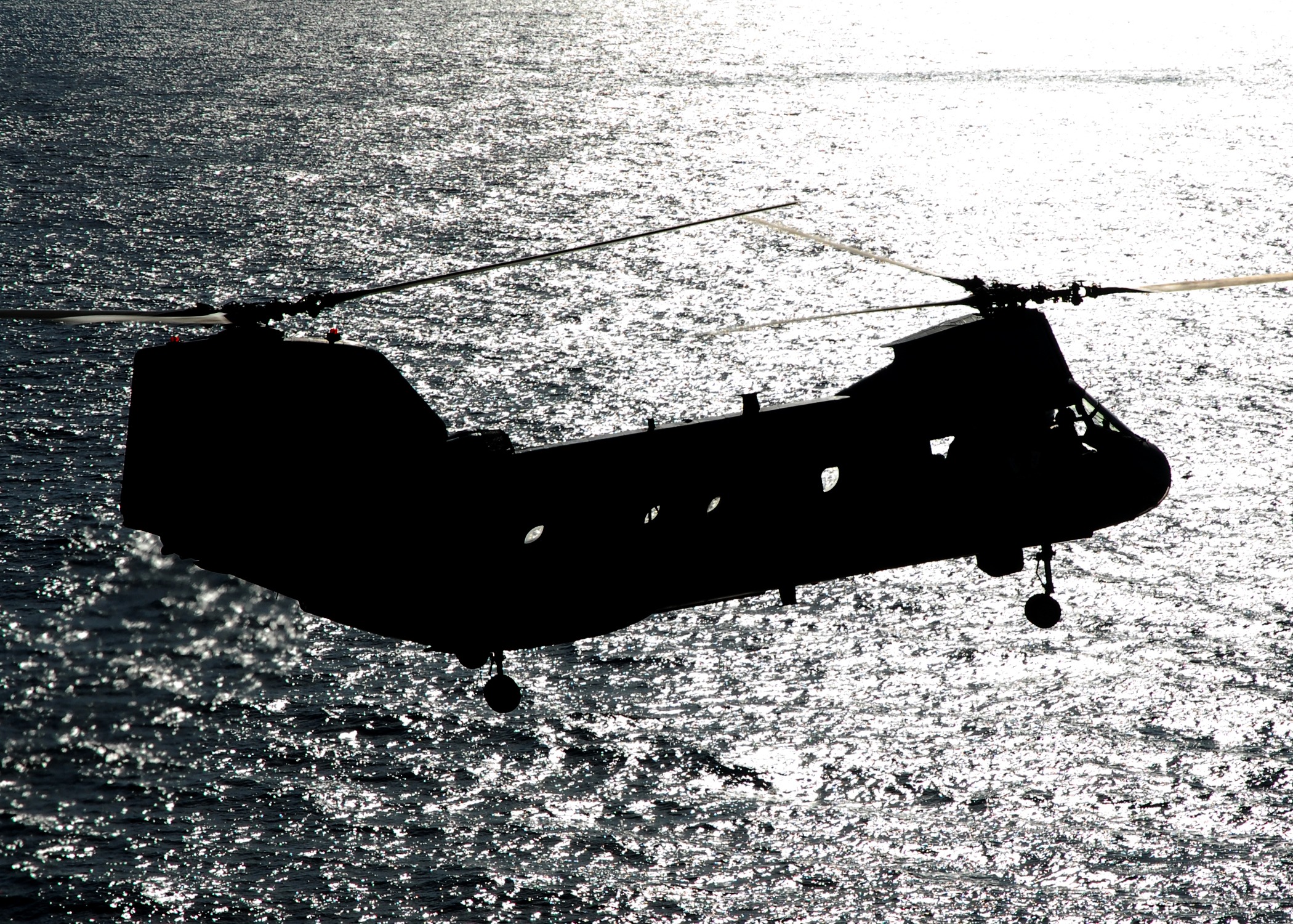 Helicopter flies over the ocean free image download