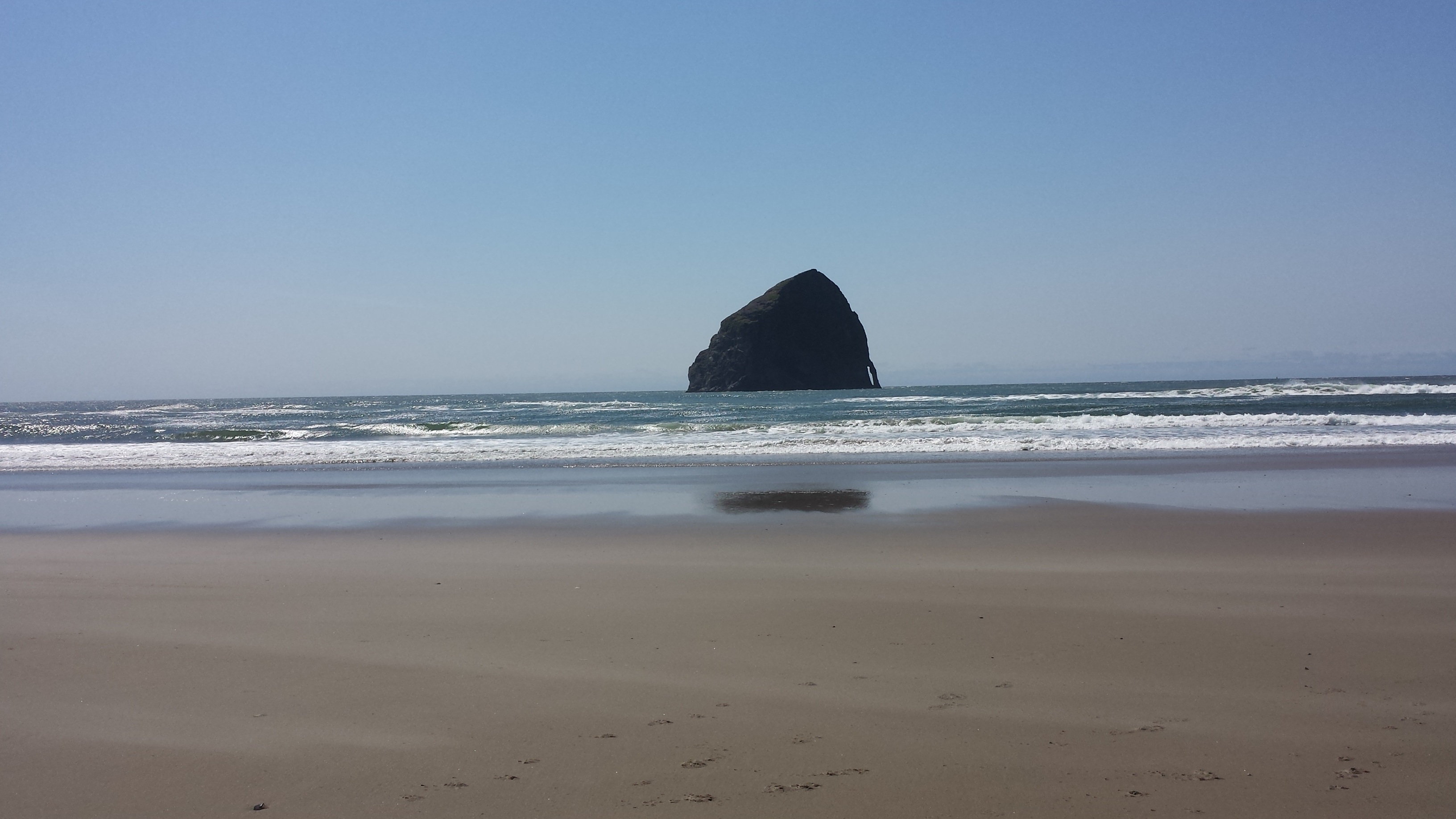 Huge rock in the ocean off the coast free image download