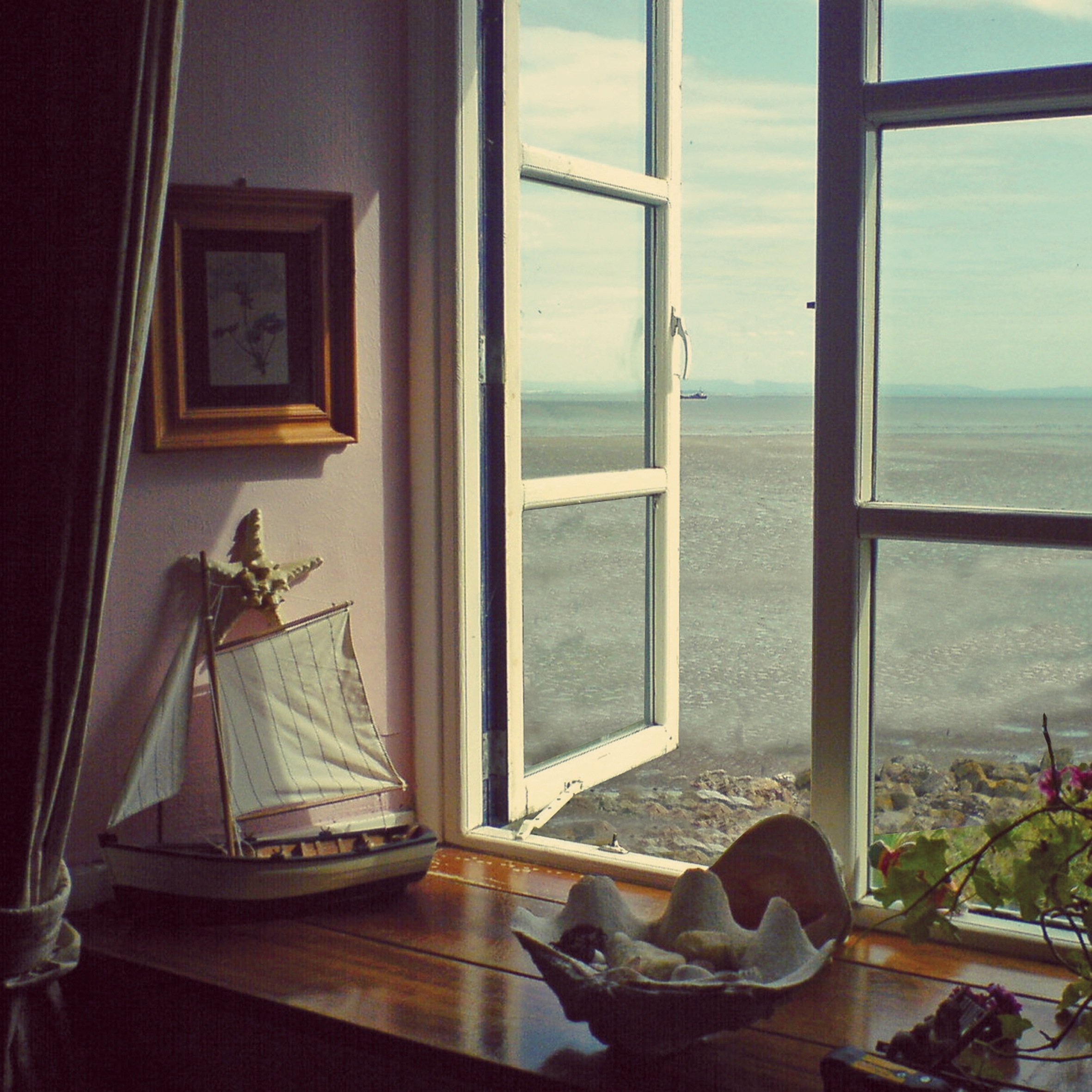 View of seaside from window of vintage room free image download