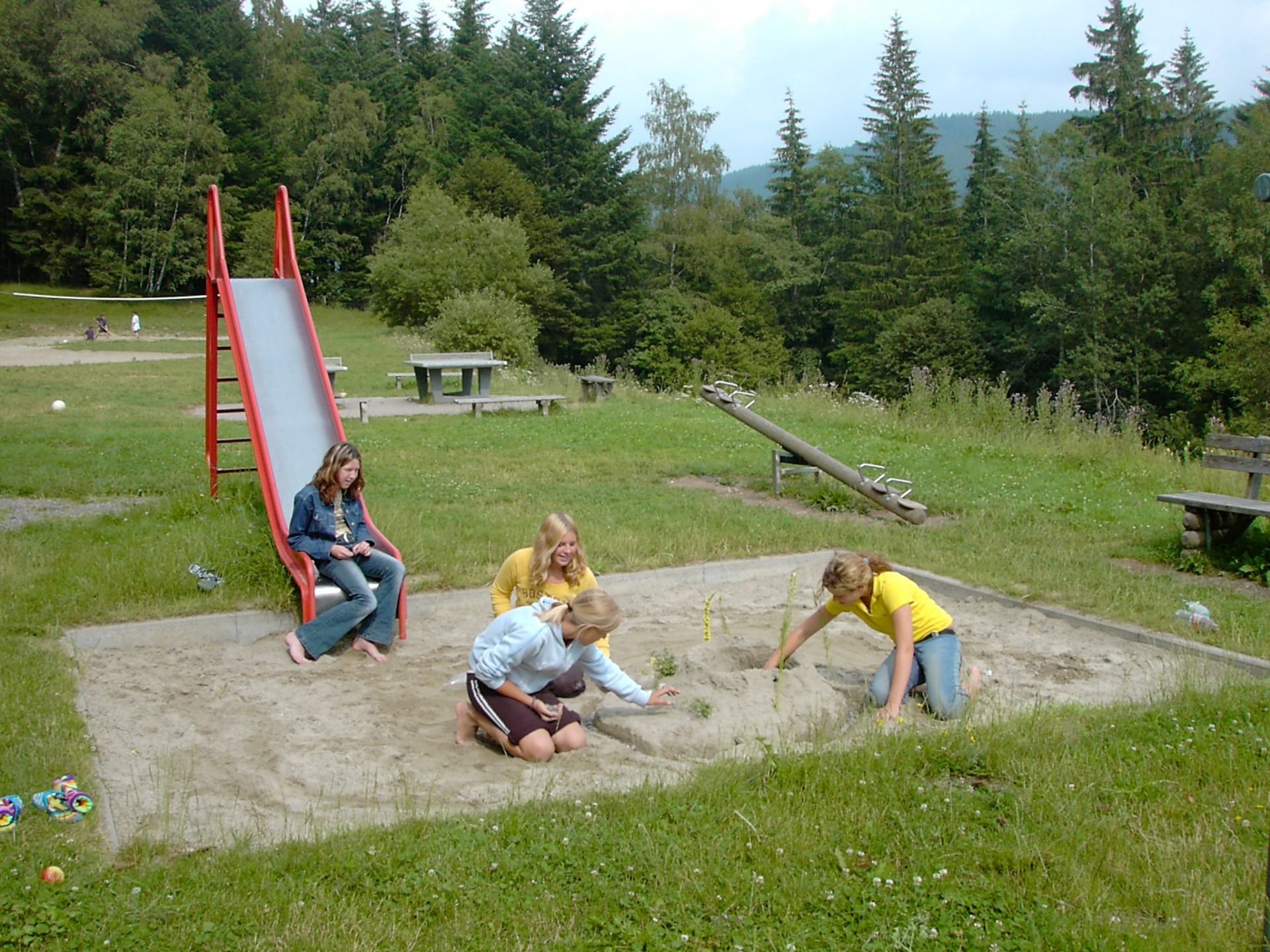 Children playing in sand pit on playground free image download
