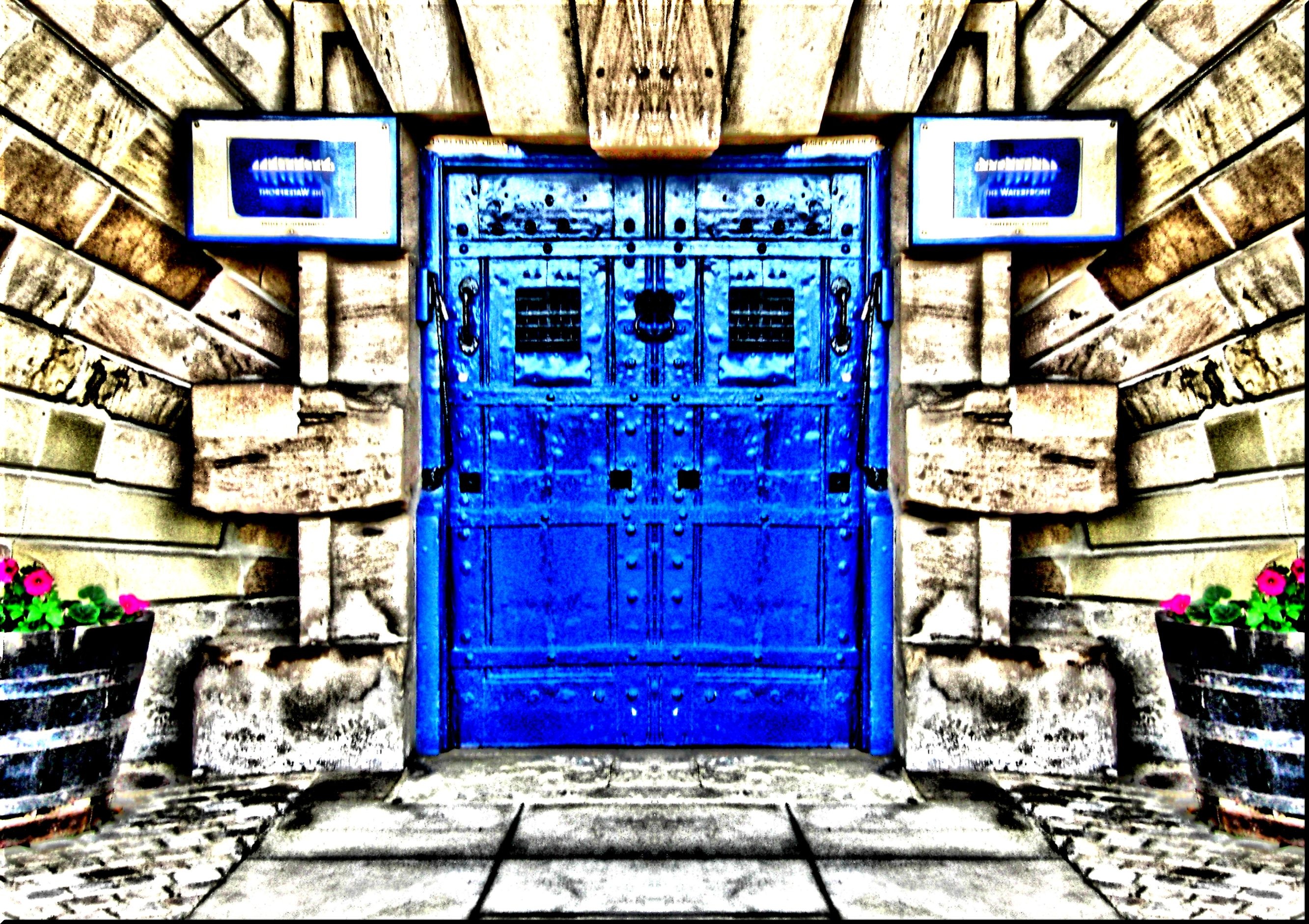 Blue door in the stone building free image download