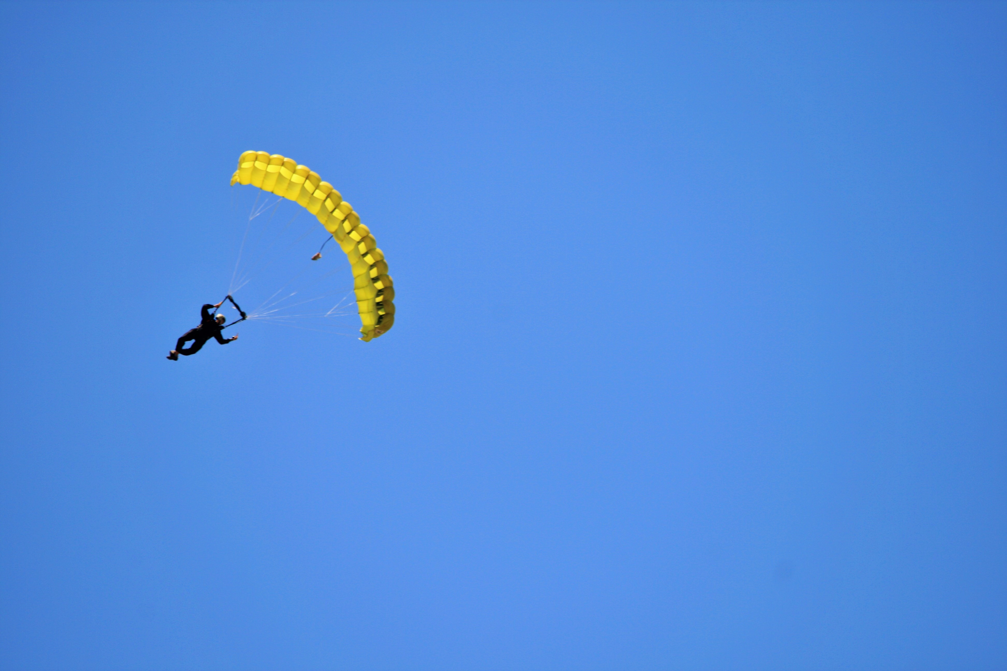 Skydiver in bright blue sky free image download