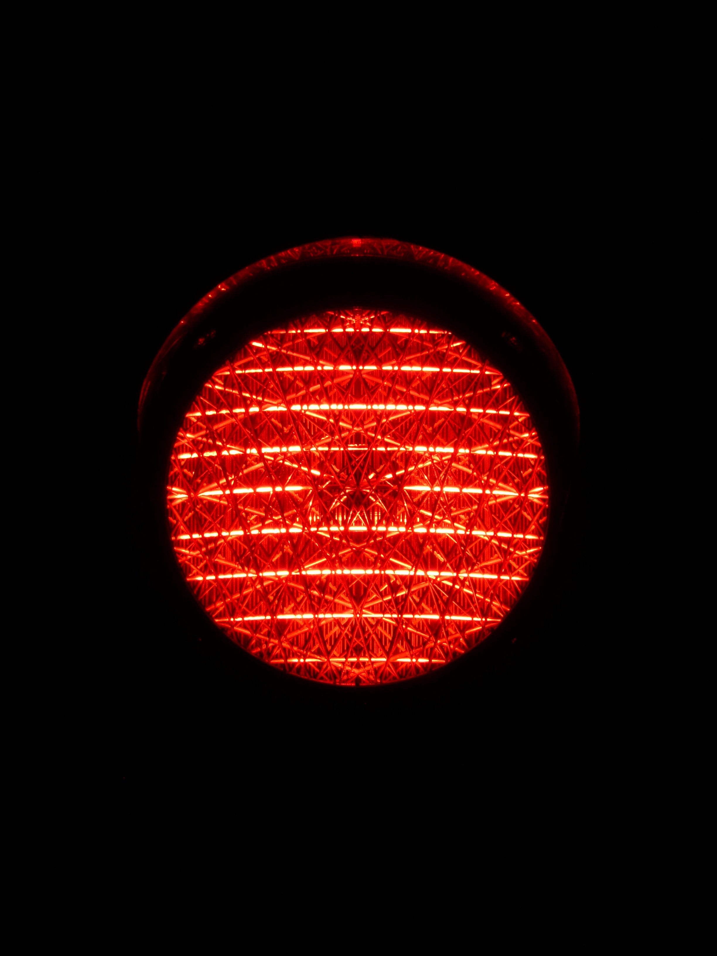 Red traffic light on a black background free image download