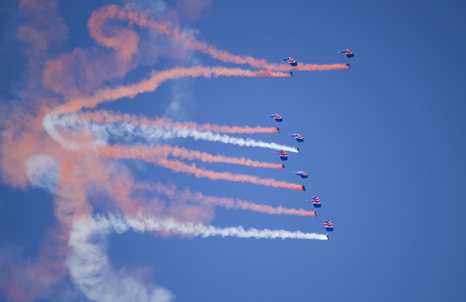 Skydivers fly and leave a trail free image download