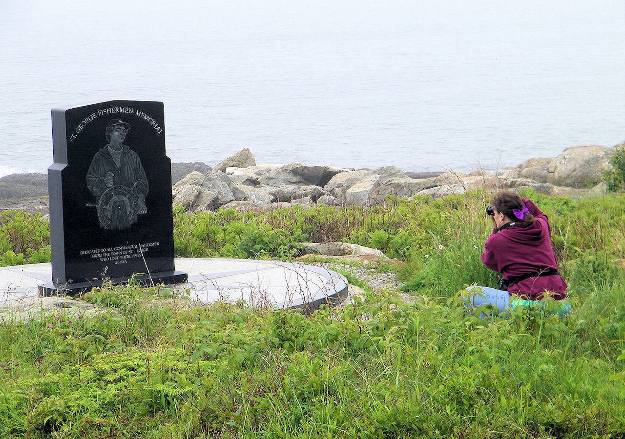 Woman with camera near grave monument free image download