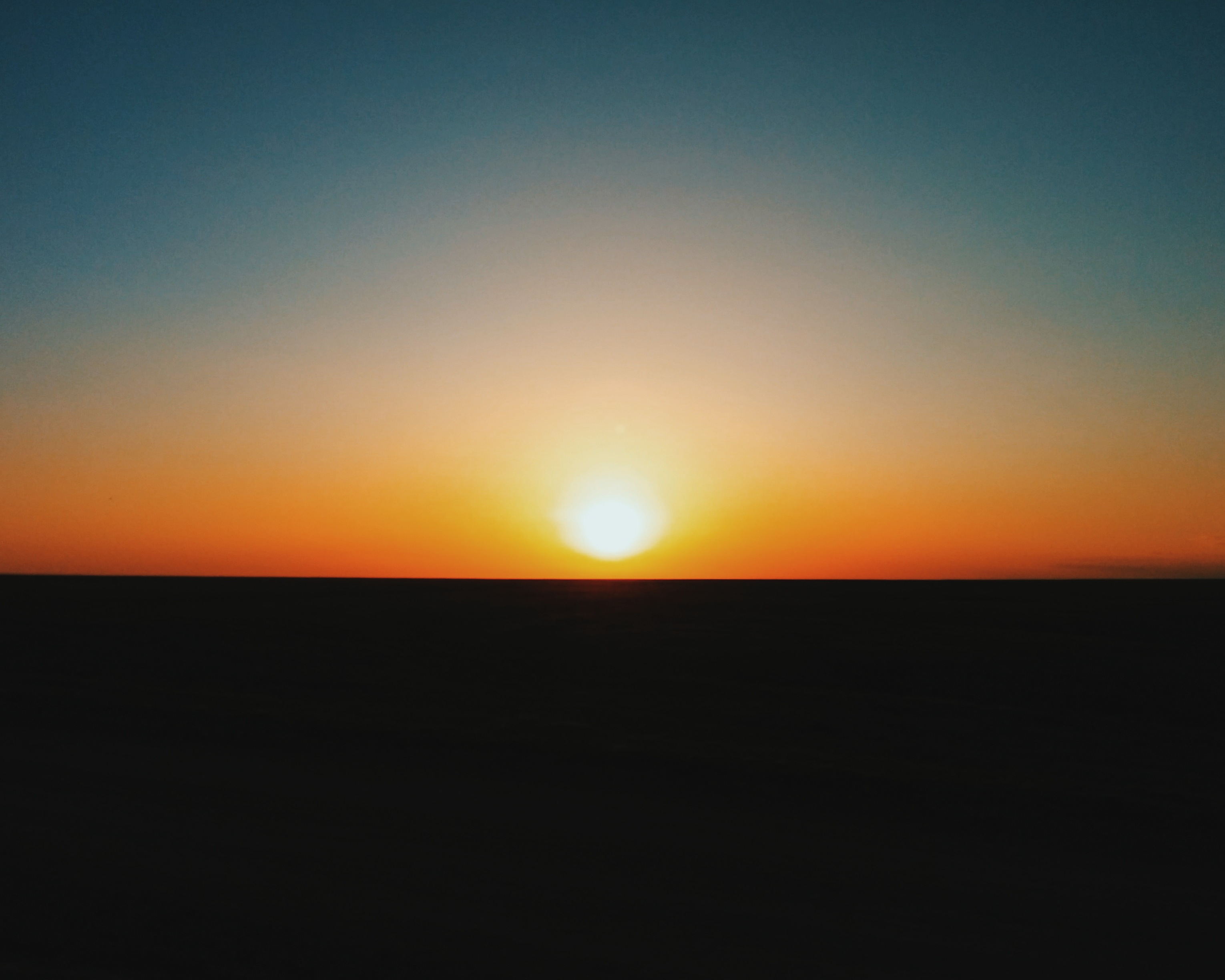 Glow of orange sunset in the dark free image download