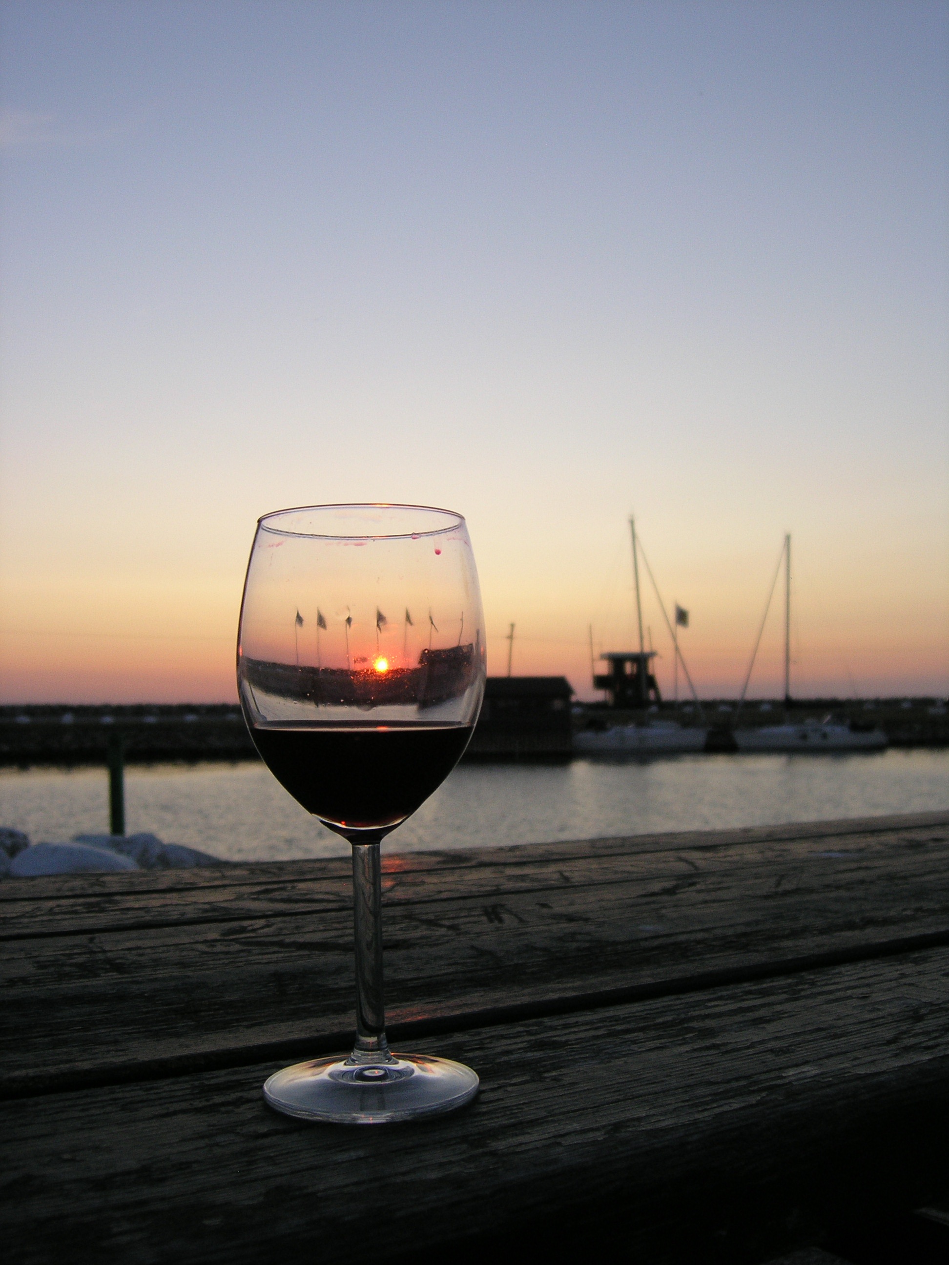 Glass of red wine on sunset background free image download