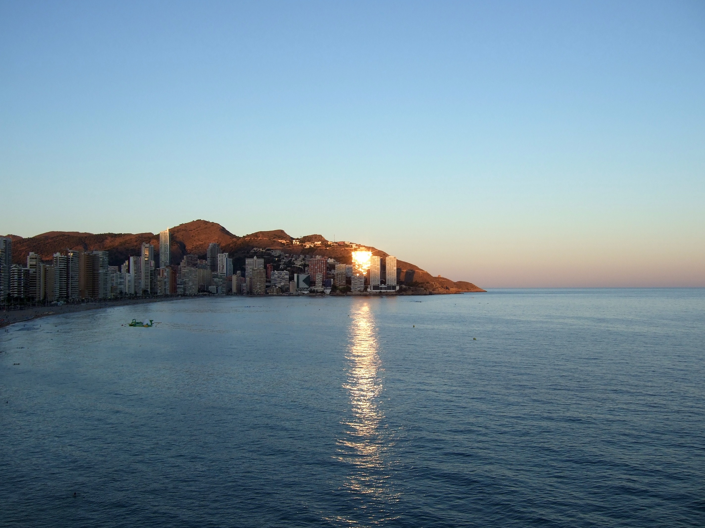 Modern city on scenic coast at sunset, spain, benidorm free image download