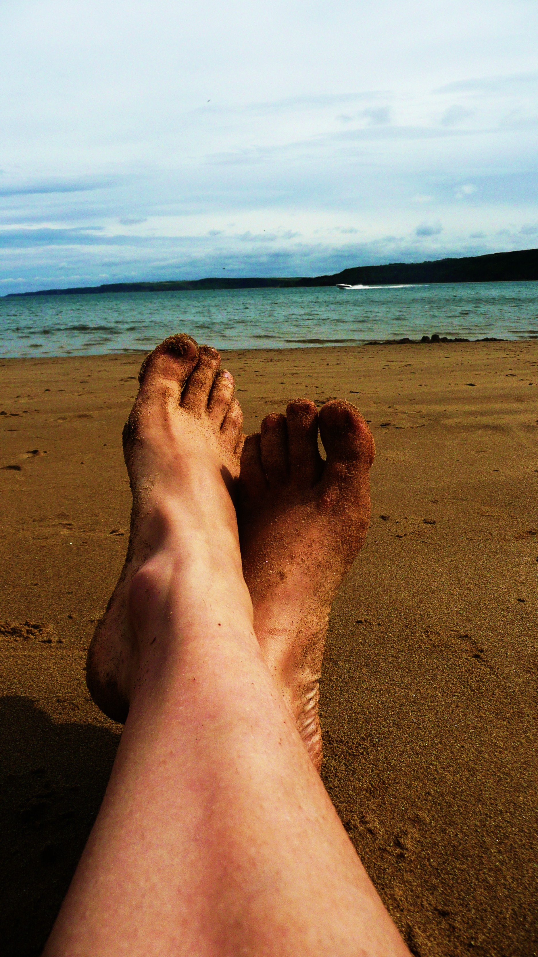 Feet on a sandy beach close up free image download