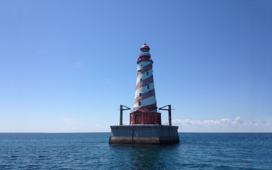 Scenic old spiral striped Lighthouse on Lake free image download