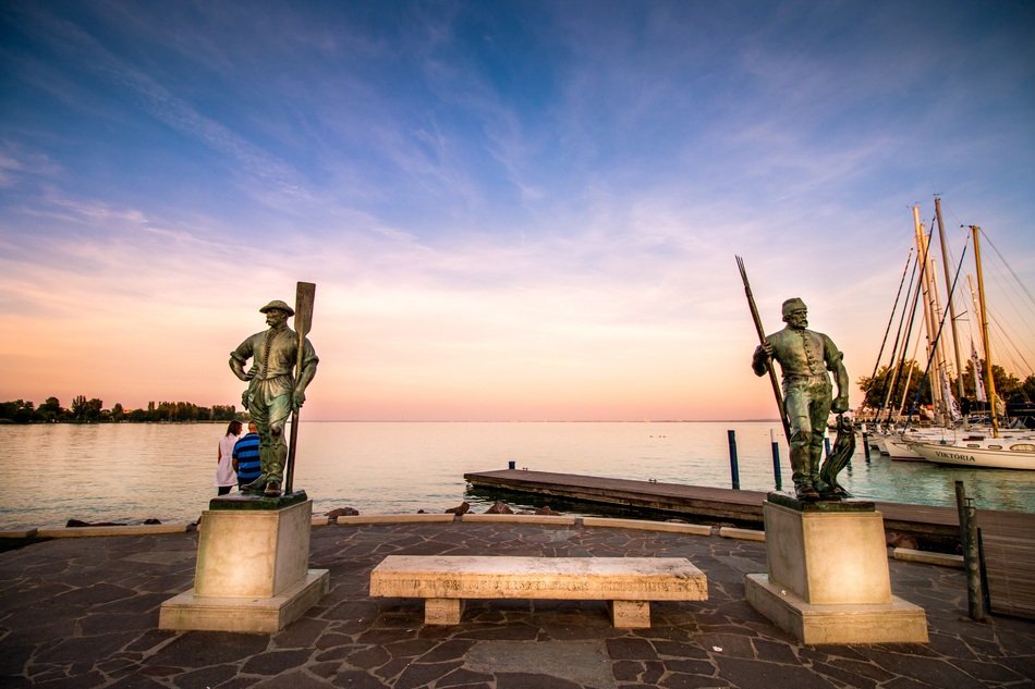Sculptures near the sea at sunset free image download