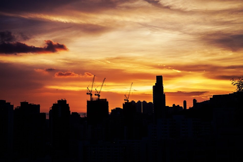 Urban buildings against the orange sky during sunset free image download