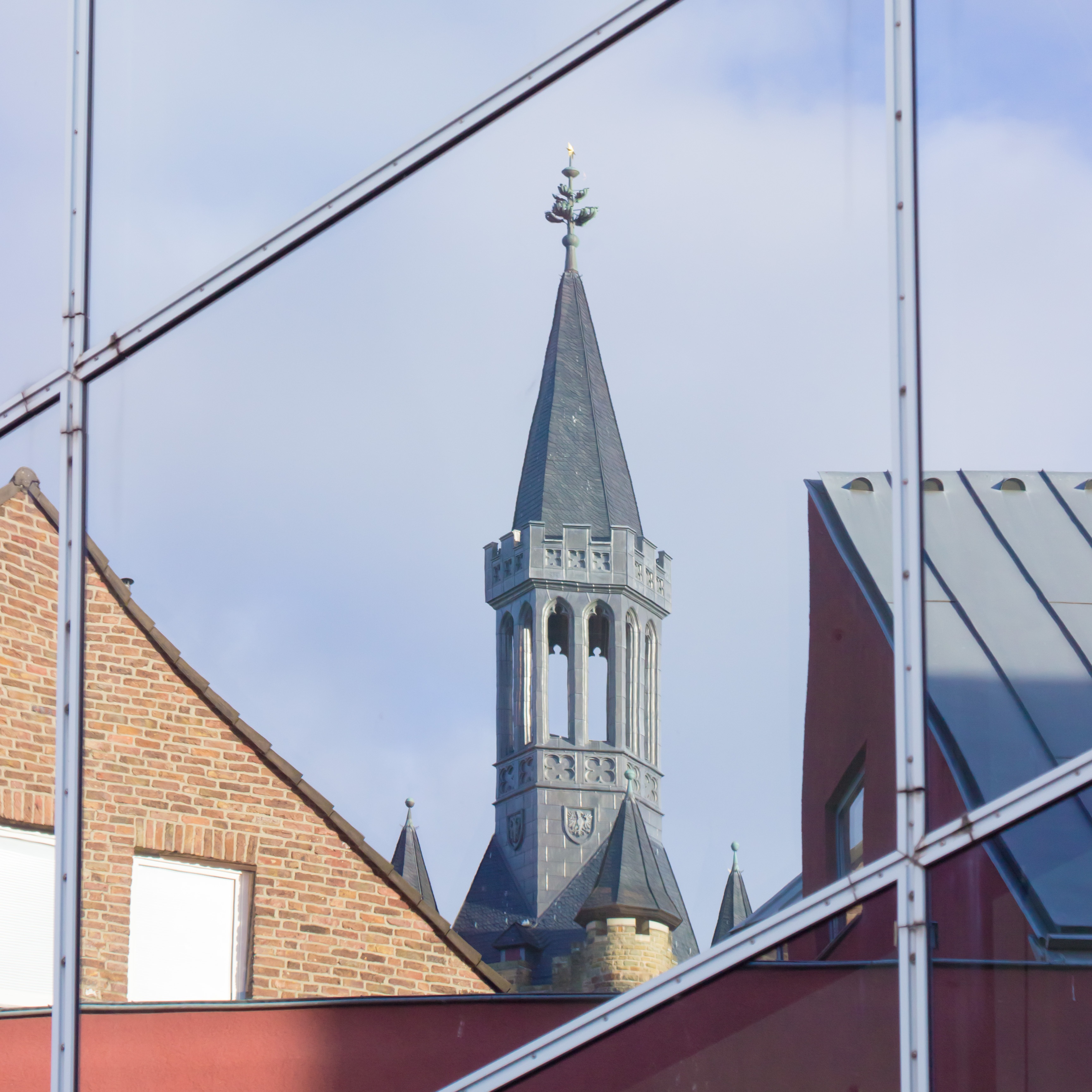 Church steeple mirroring on the glass facade free image download