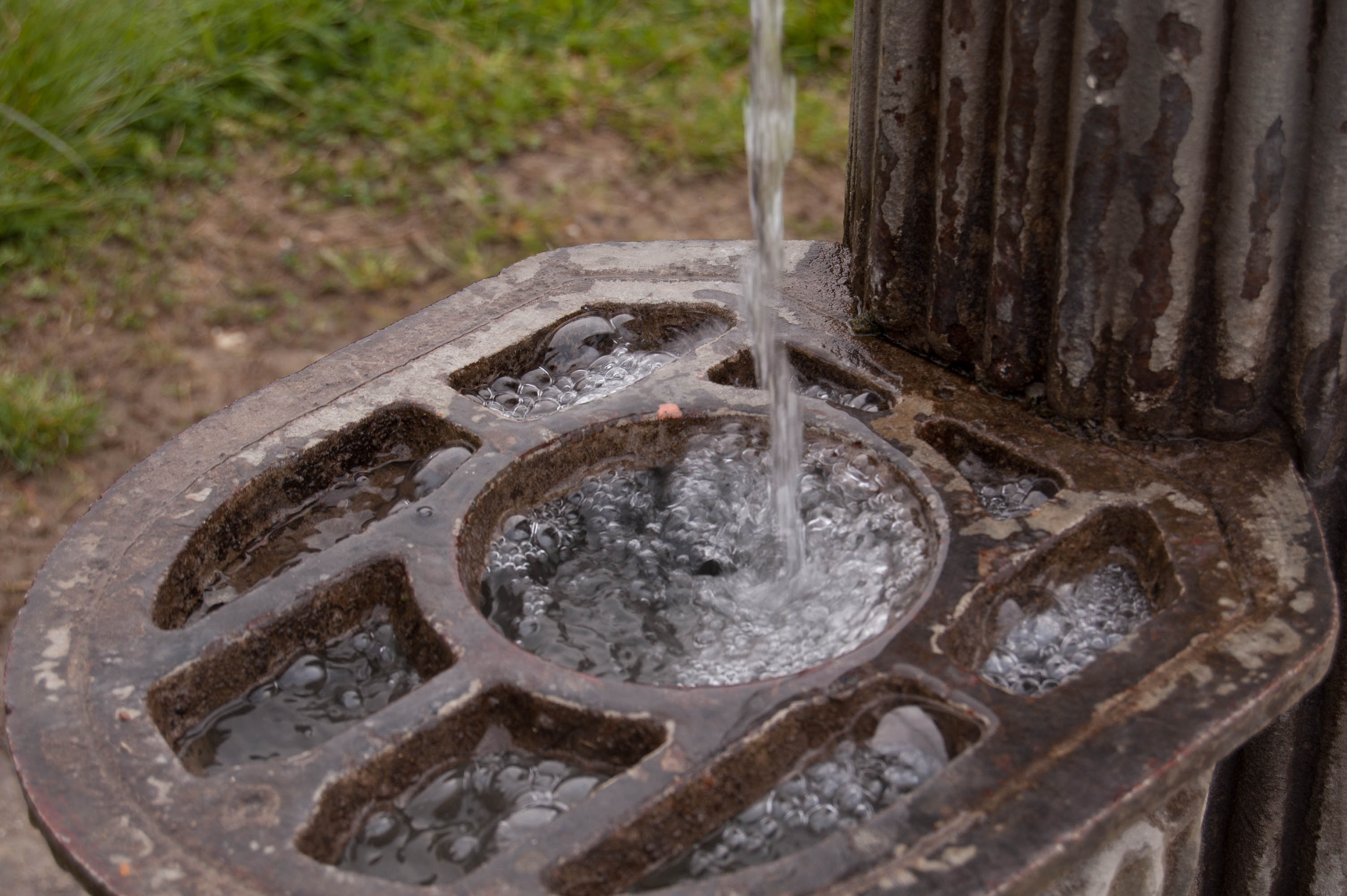 Water flows along a metal grate free image download
