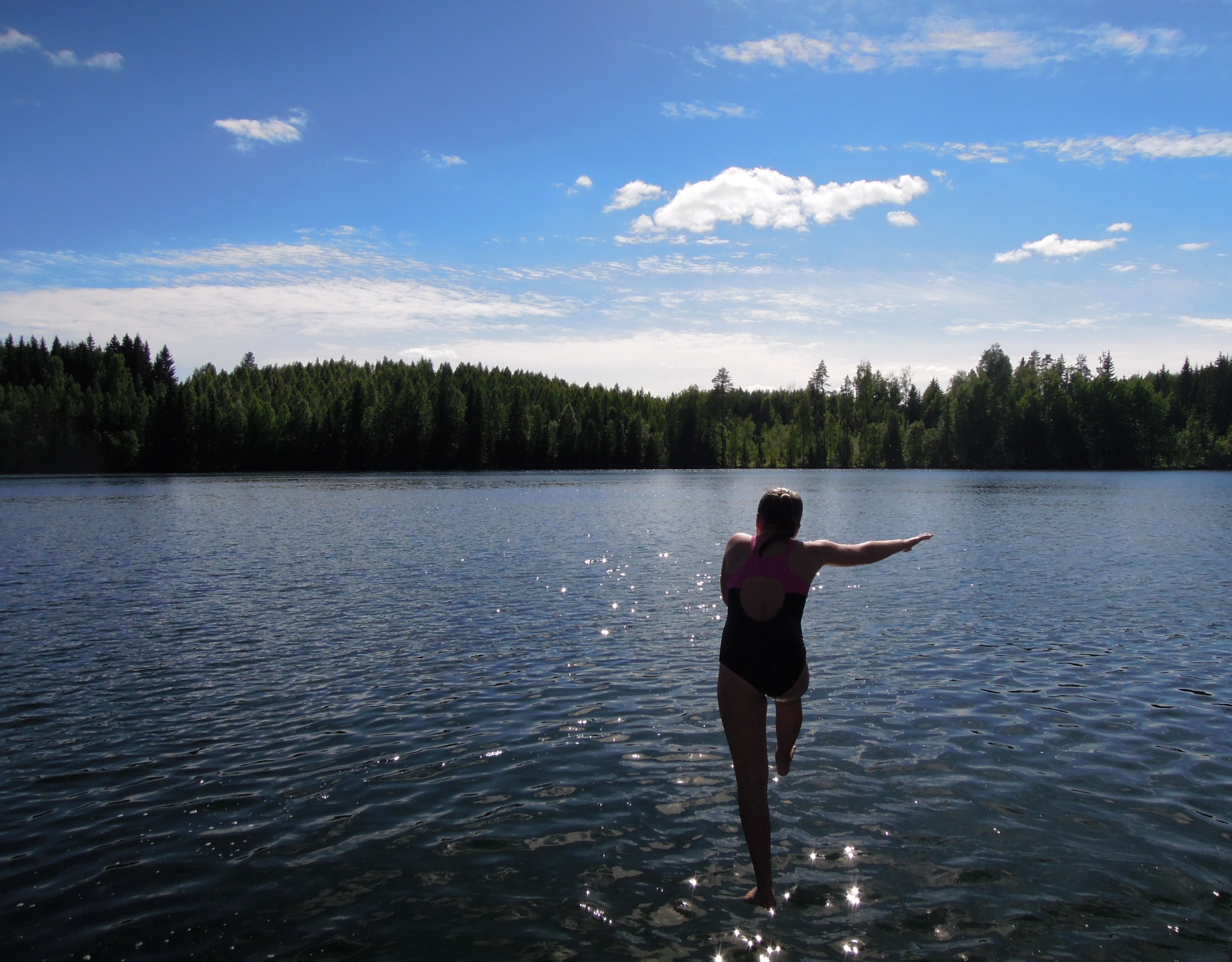 Girl with a run jumps into the Finnish lake free image download