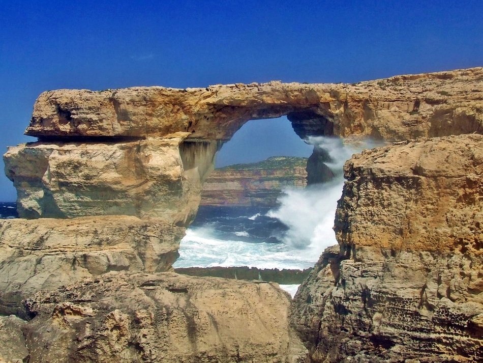 Window in a rock on the coast of Malta free image download