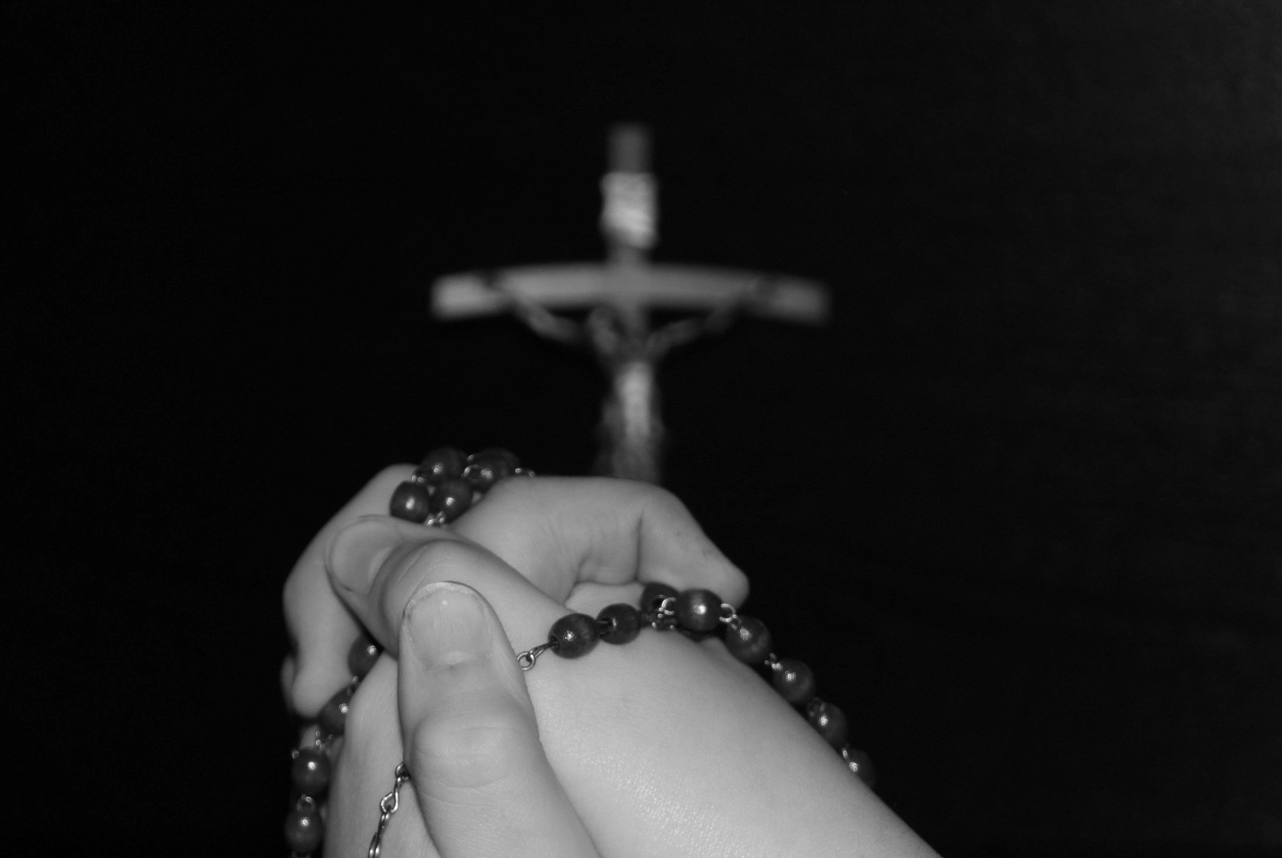 Praying human holds in hands a rosary free image download