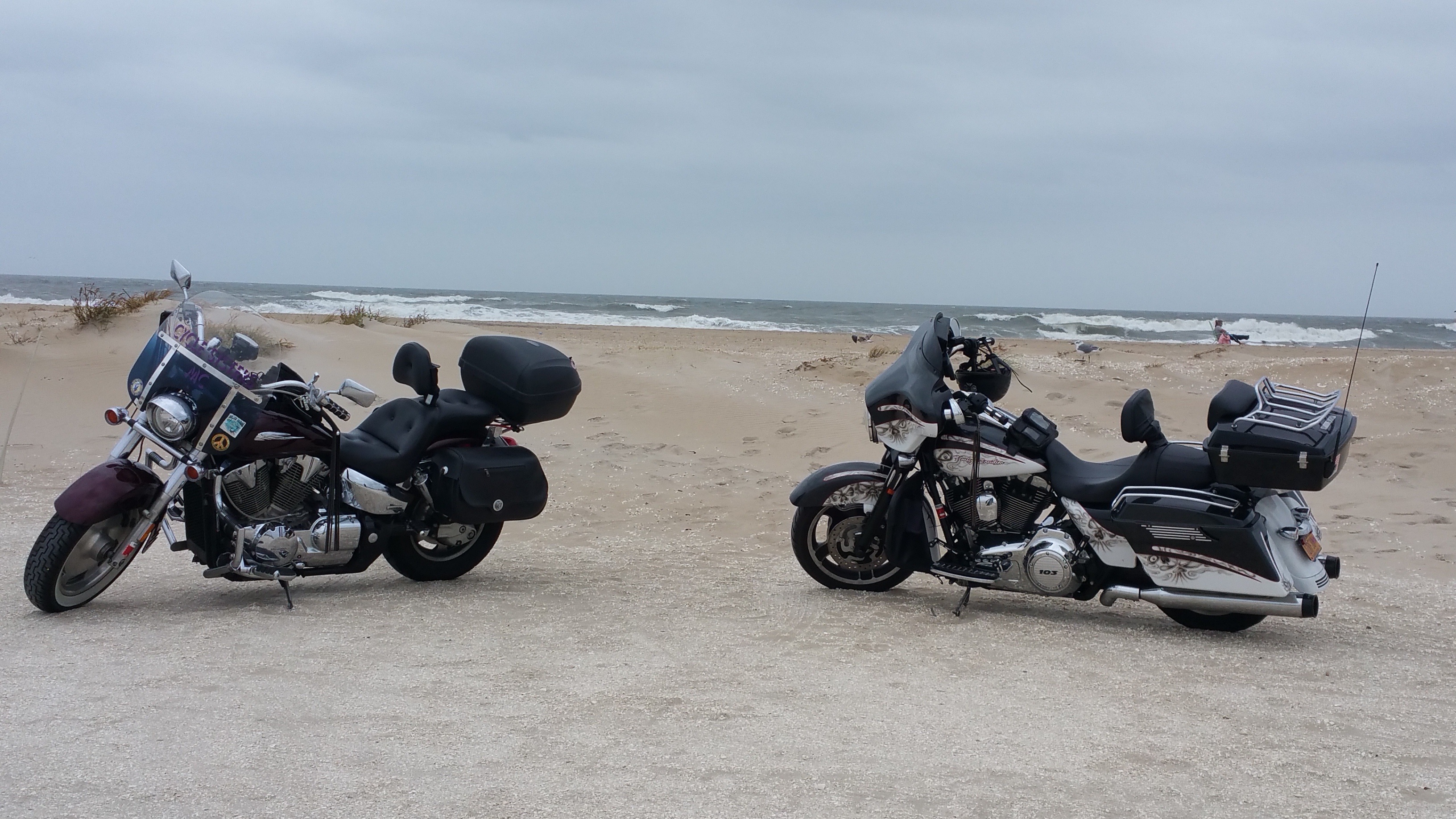 Two parked motorcycles on the beach free image download