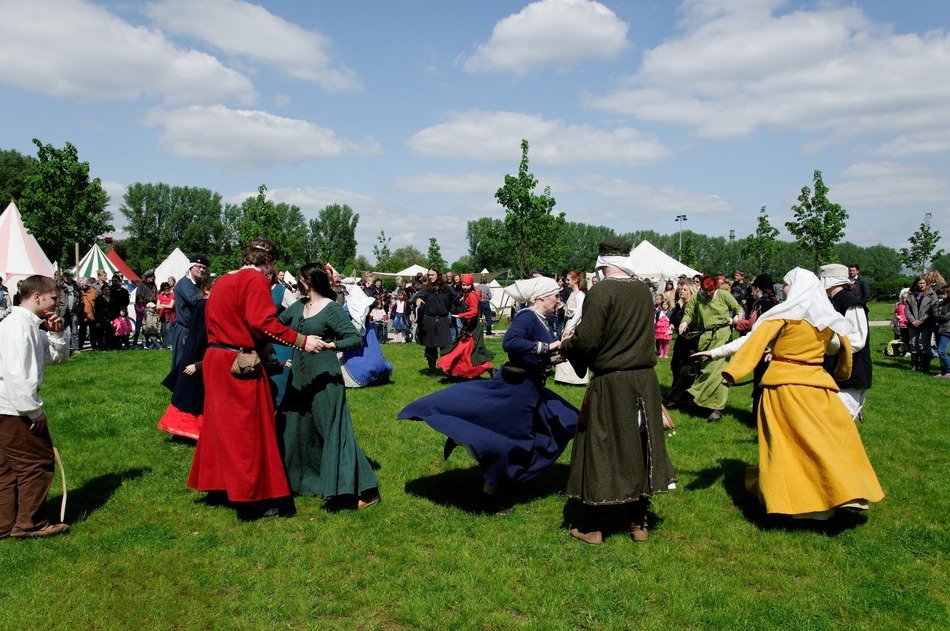 People in Medieval clothing Dancing on Meadow at market free image download