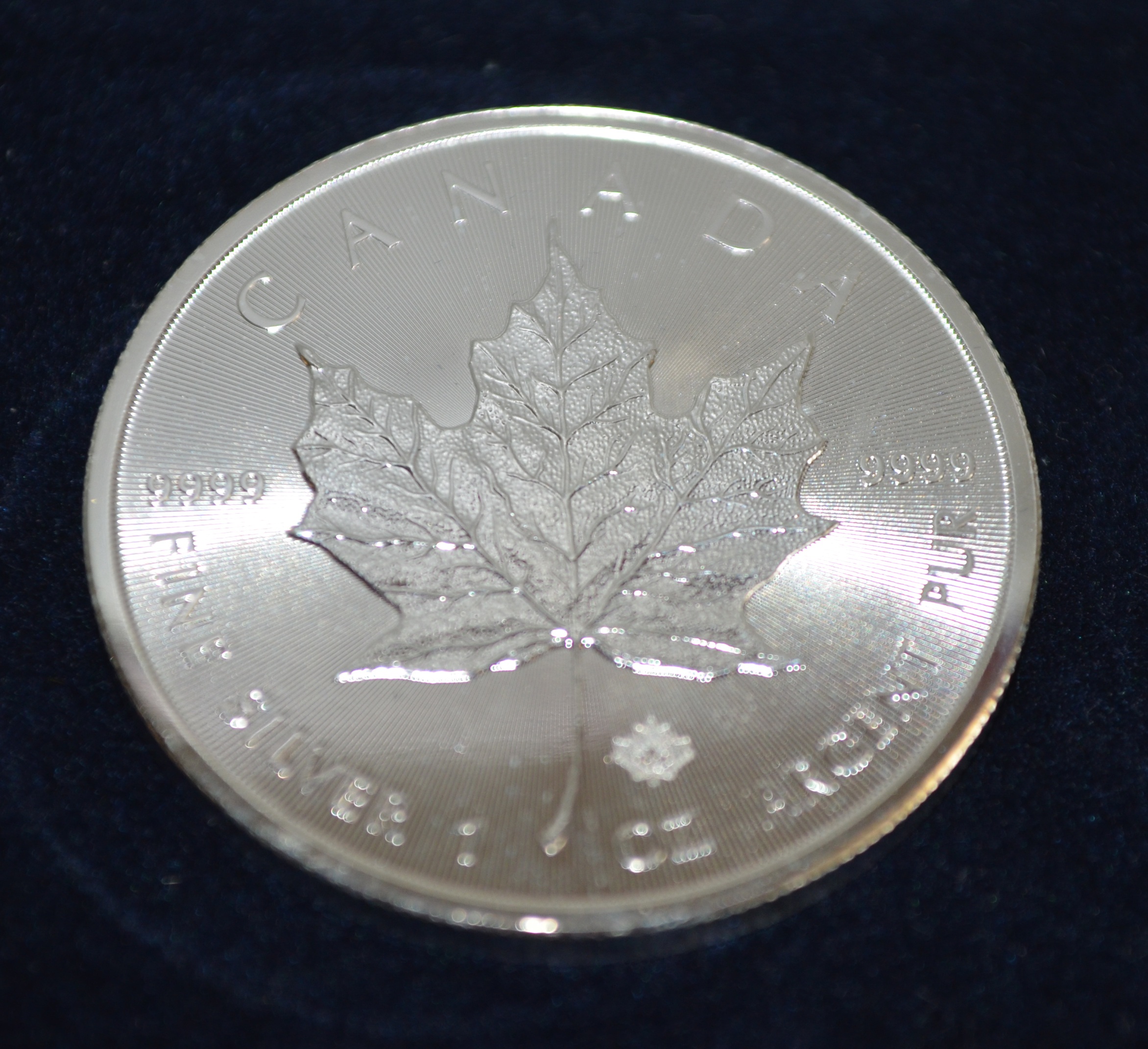 Silver coin on a black background free image download