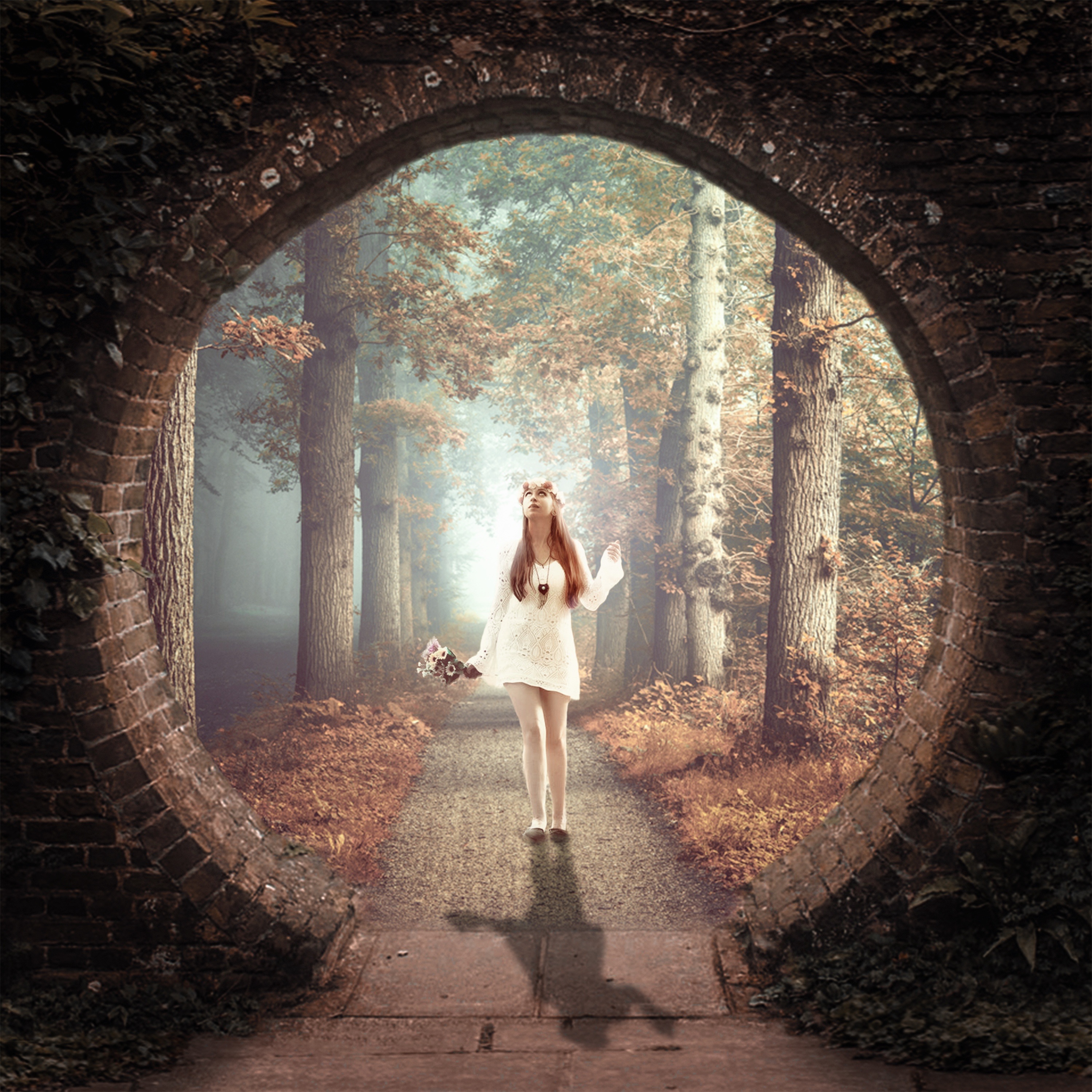 Pretty girl with bouquet walking on path through Forest to gateway ...