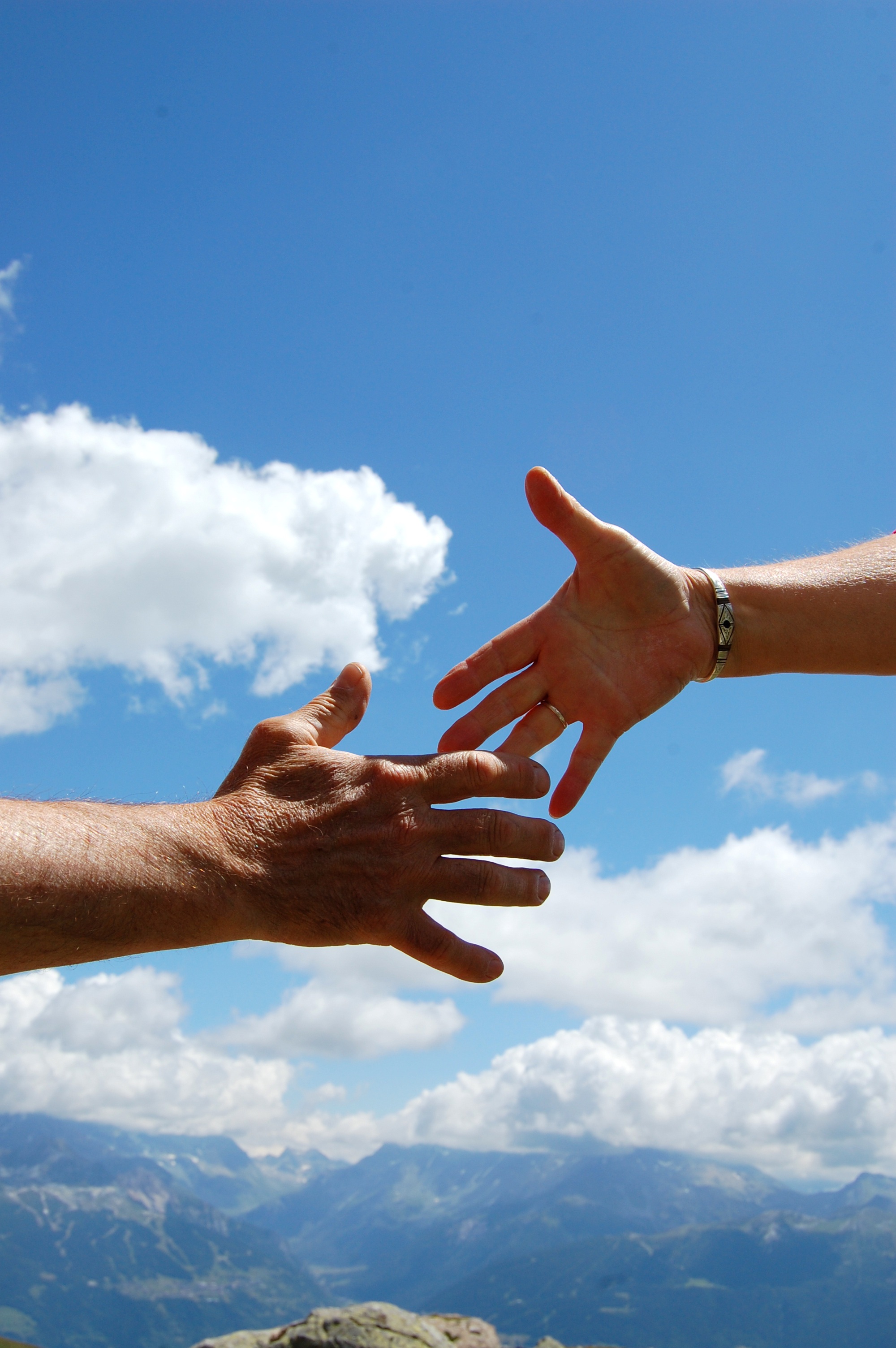 Hands of people reach out to each other against the background of ...