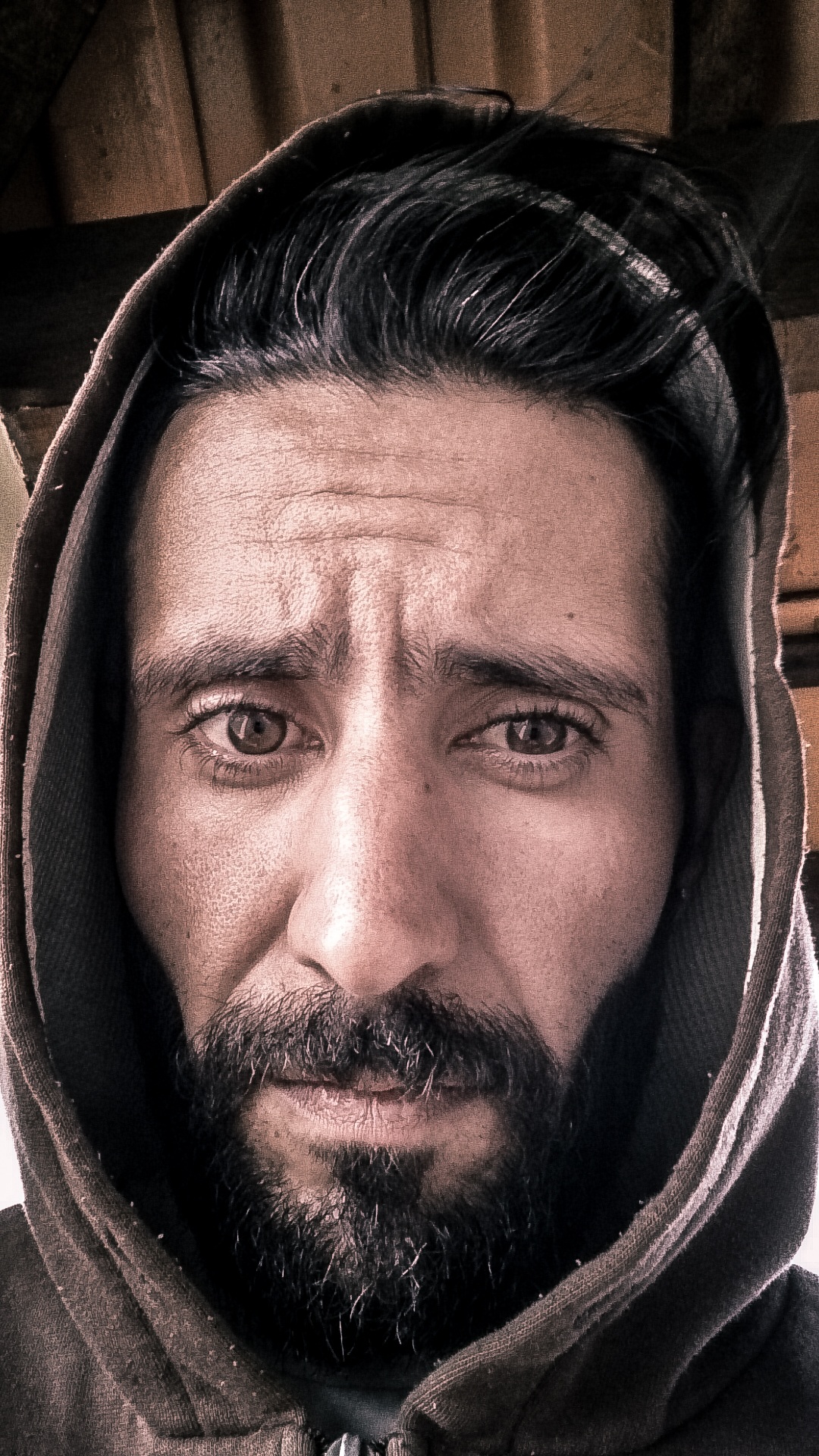 Head of a man with a beard in a hood free image download
