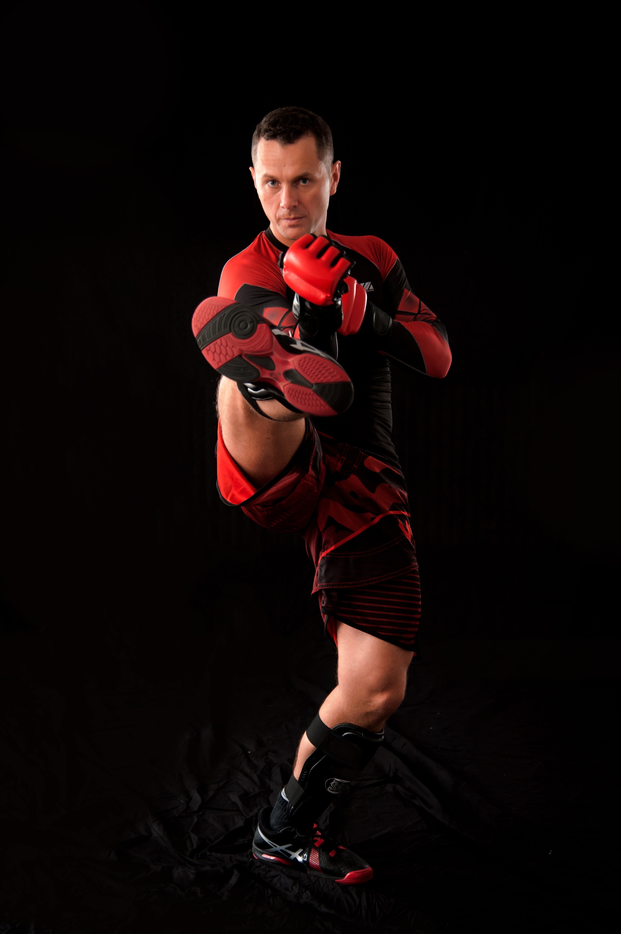 Kick boxing, adult man in gloves at darkness free image download