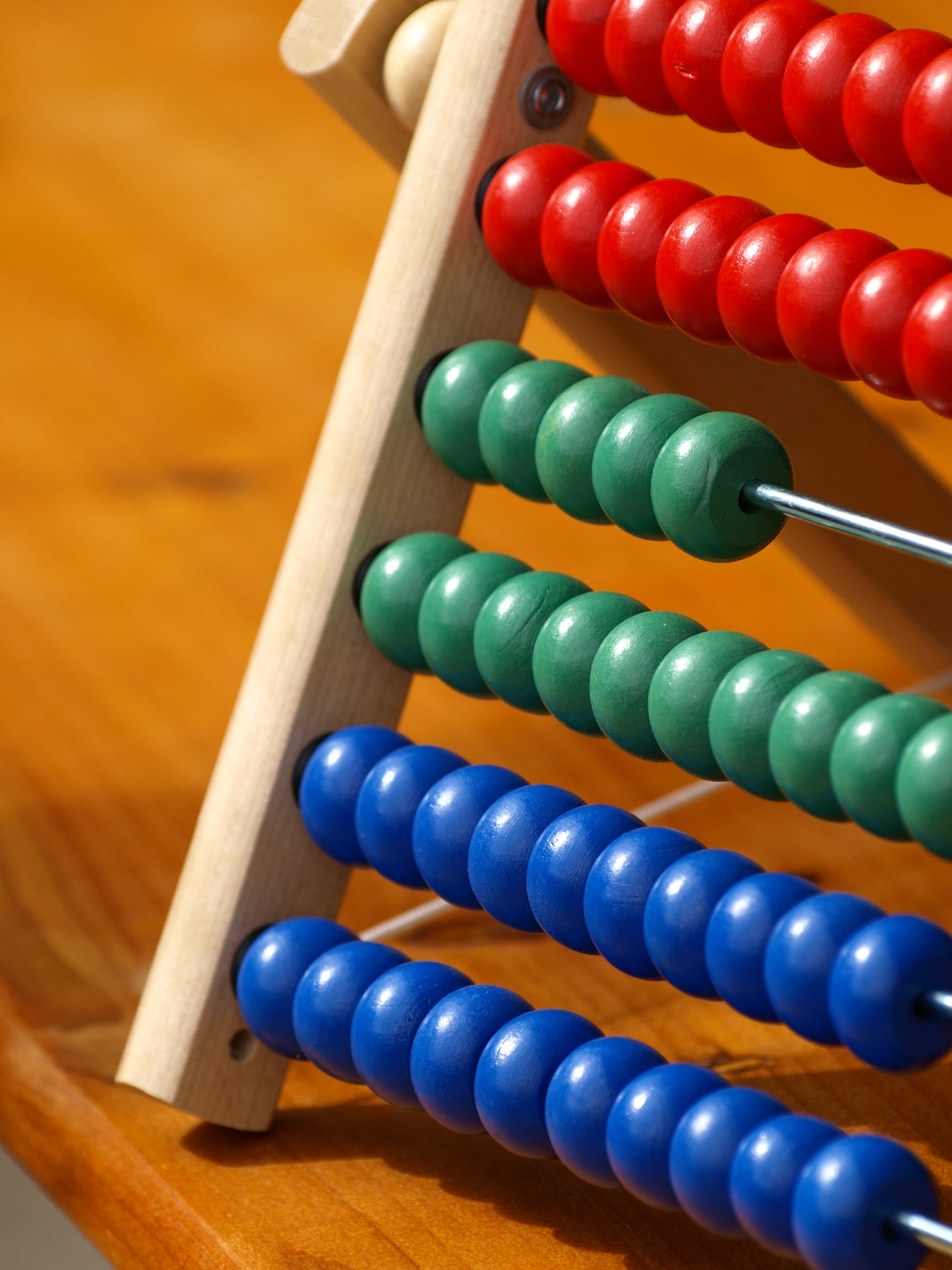 Wooden abacus of different colors on a wooden surface free image download