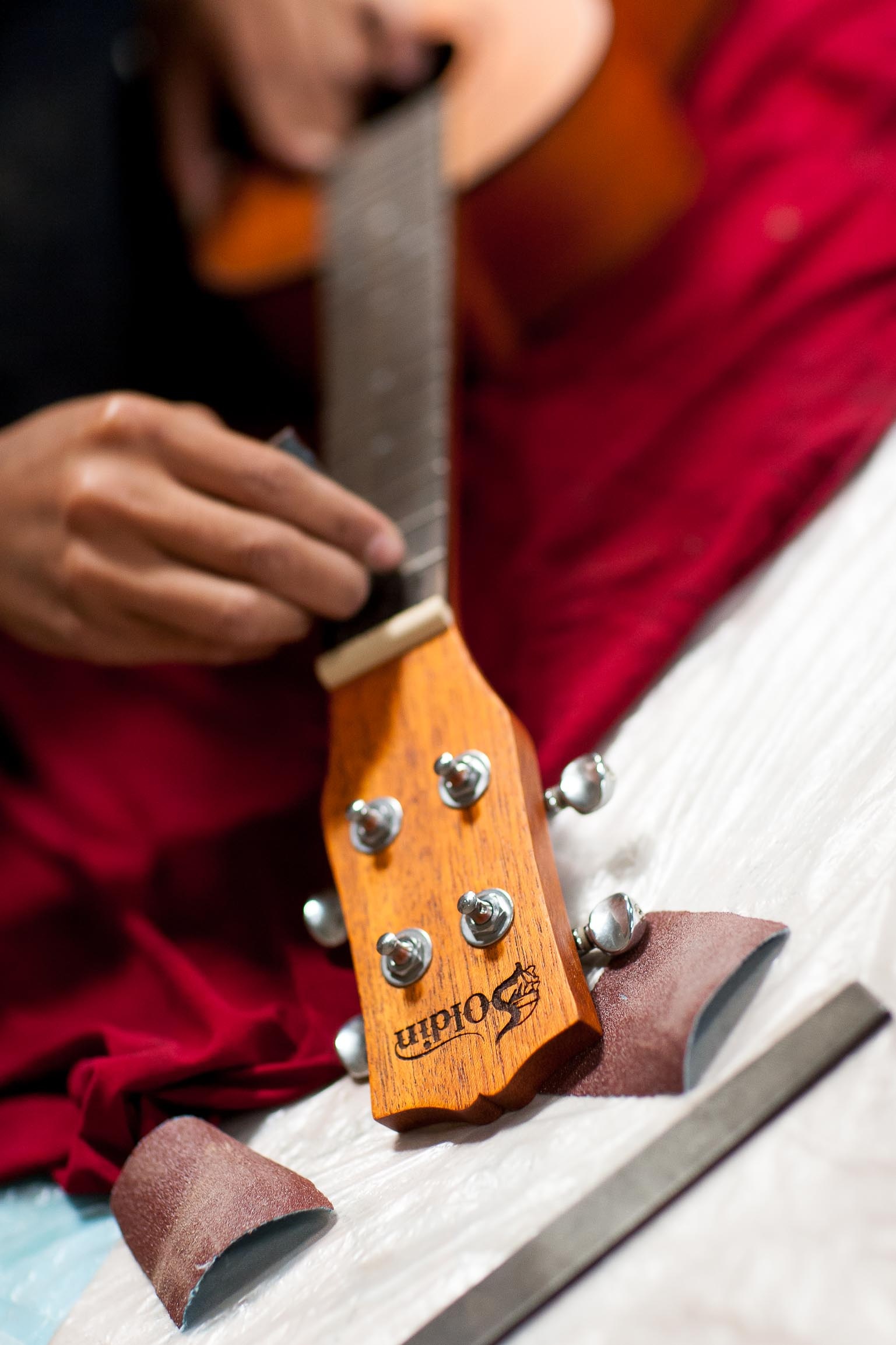Person, touching strings of the wooden guitar free image download