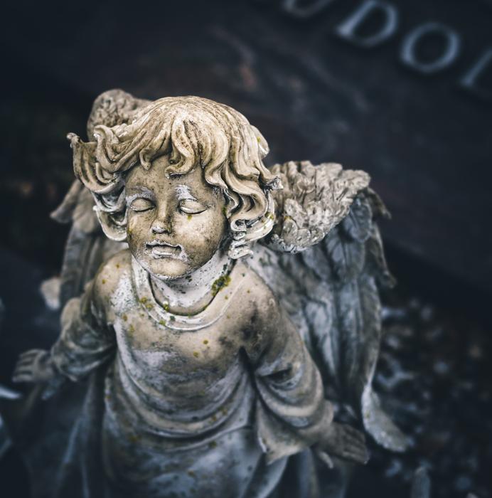 Sculpture of a lonely angel with closed eyes free image download