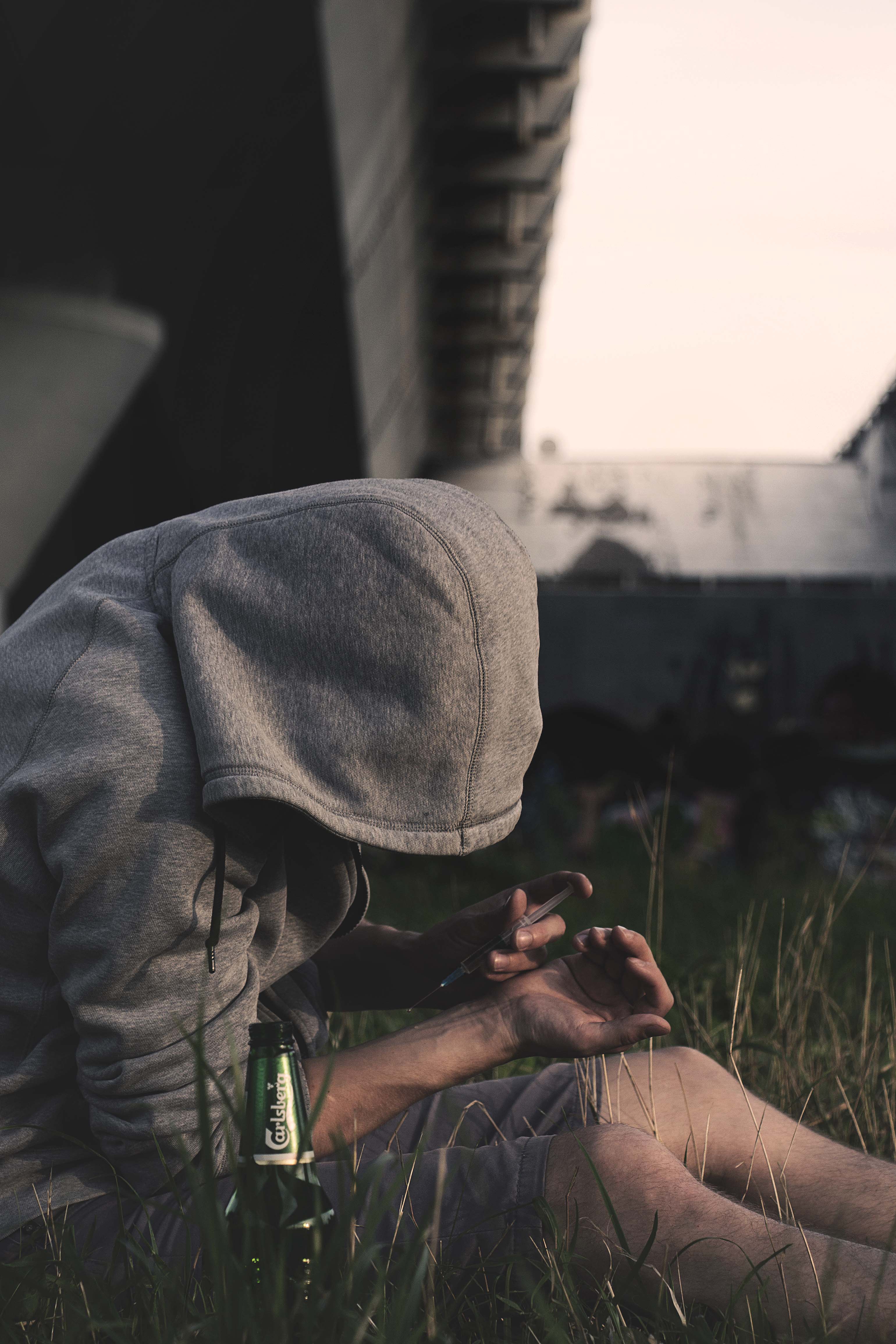Person with drug addiction, covered in a hood free image download