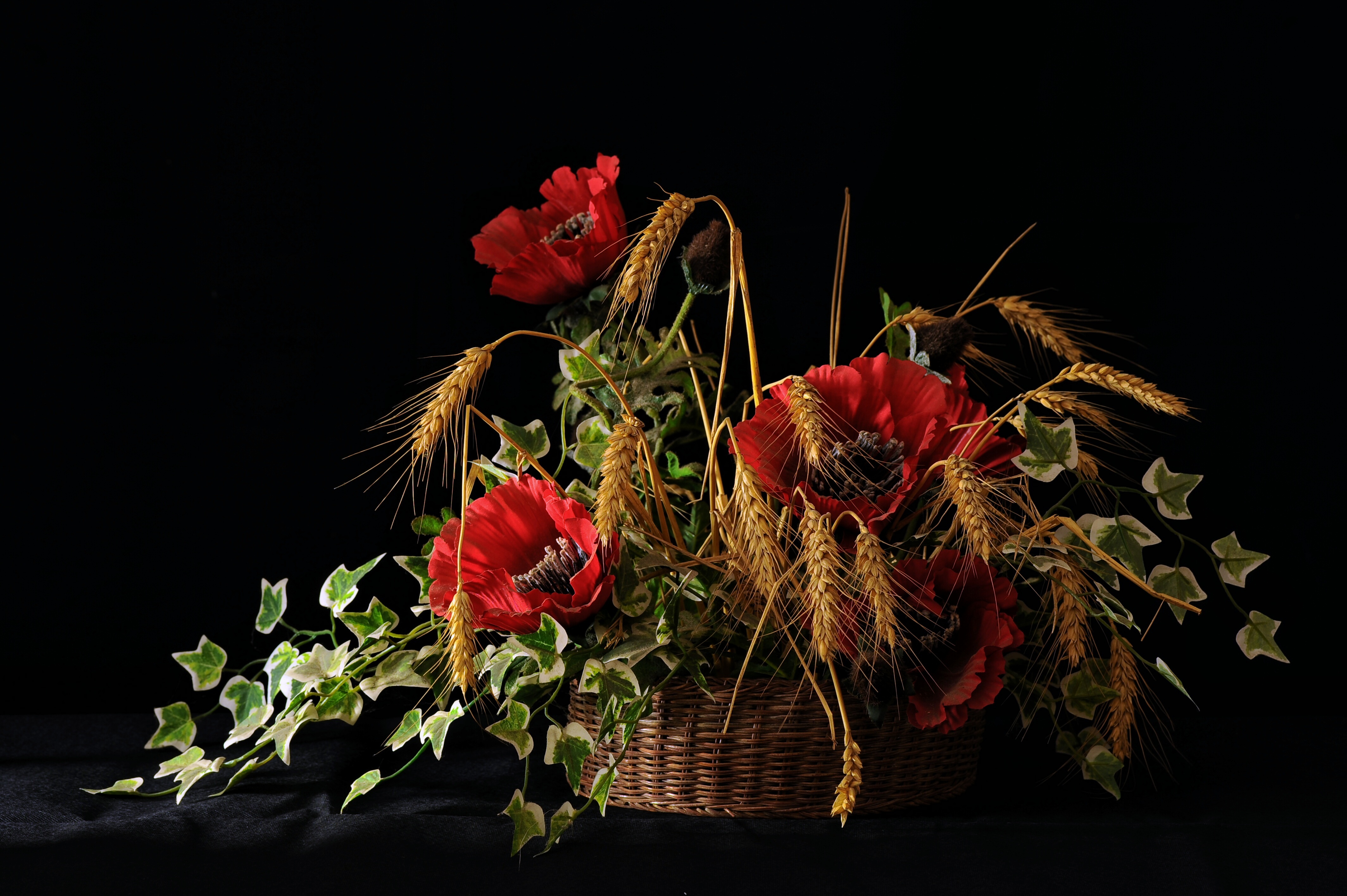 Beautiful wicker basket with beautiful, red poppy flowers, green leaves ...