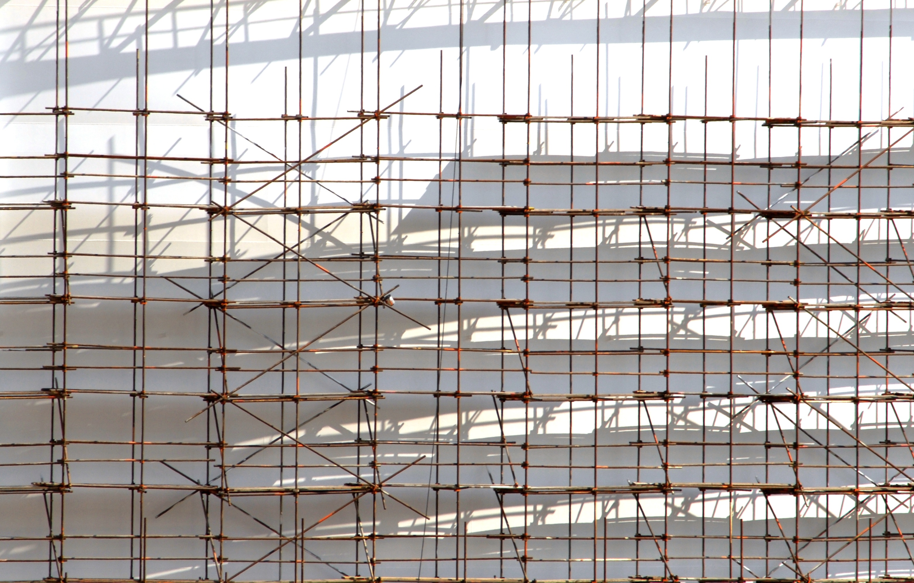 The shadow of the scaffolding on the facade of the building free image ...
