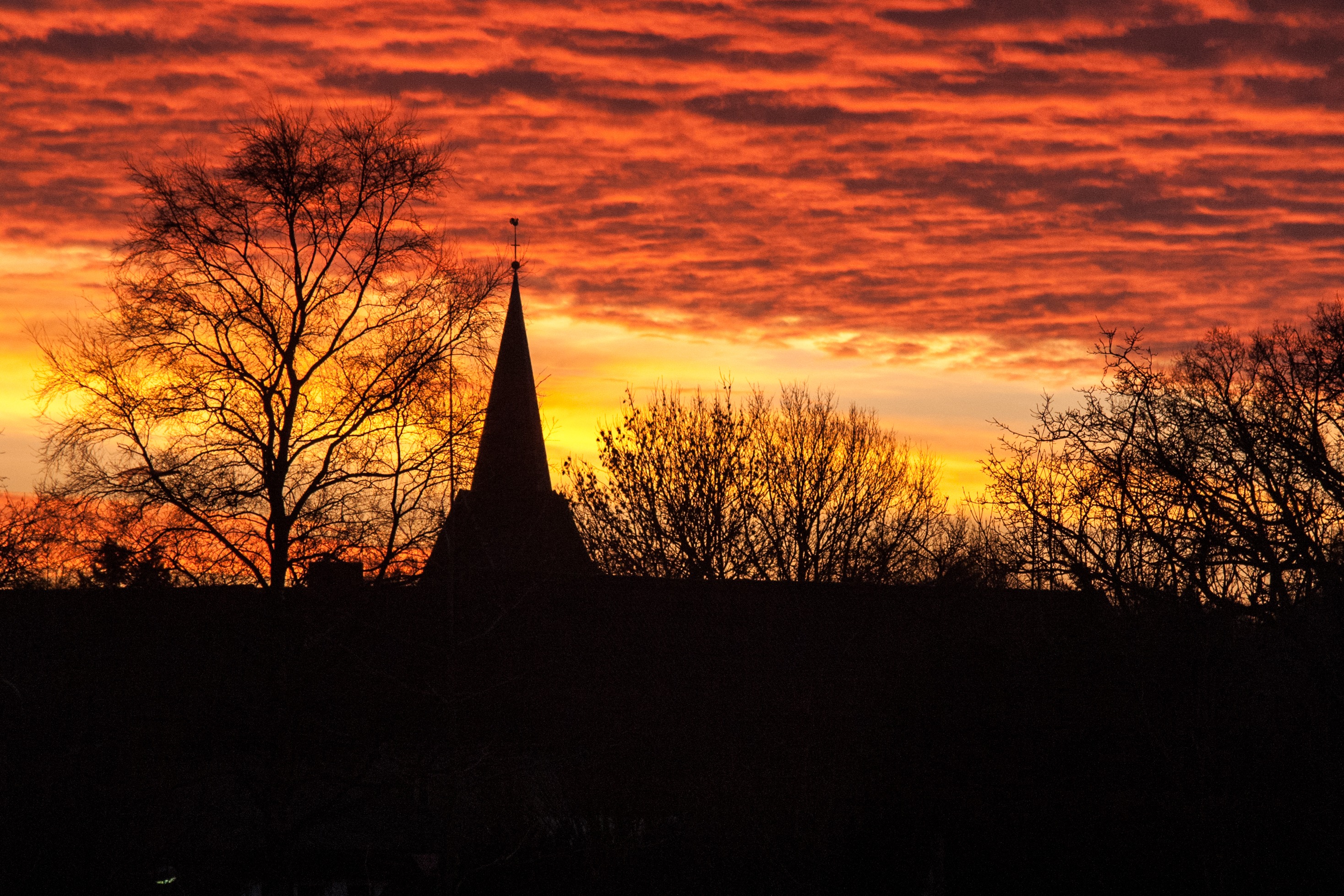 Silhouette of a church spire at sunset free image download