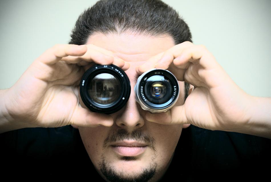 Portrait of man with camera lenses free image download