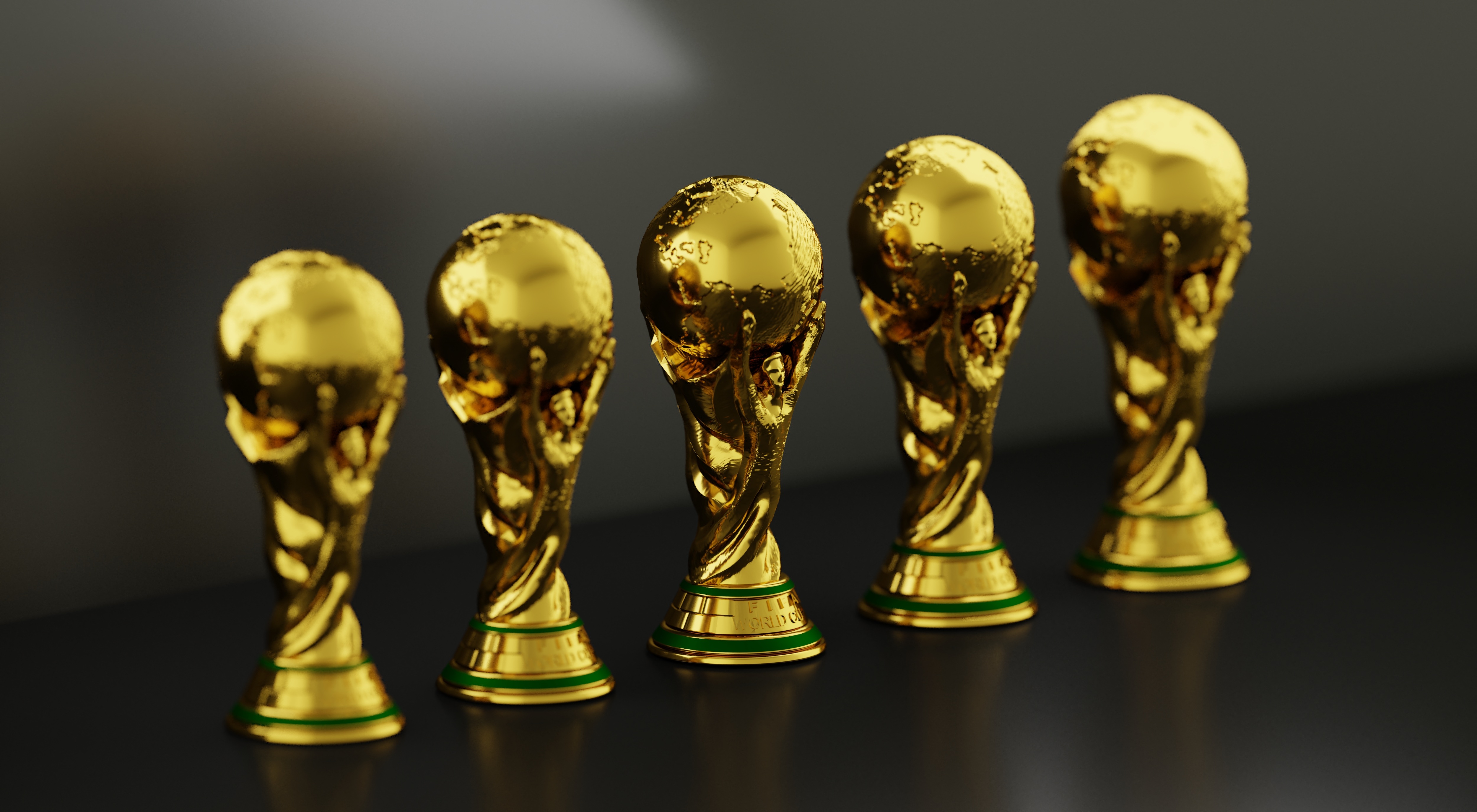 Five football cups on a dark background free image download
