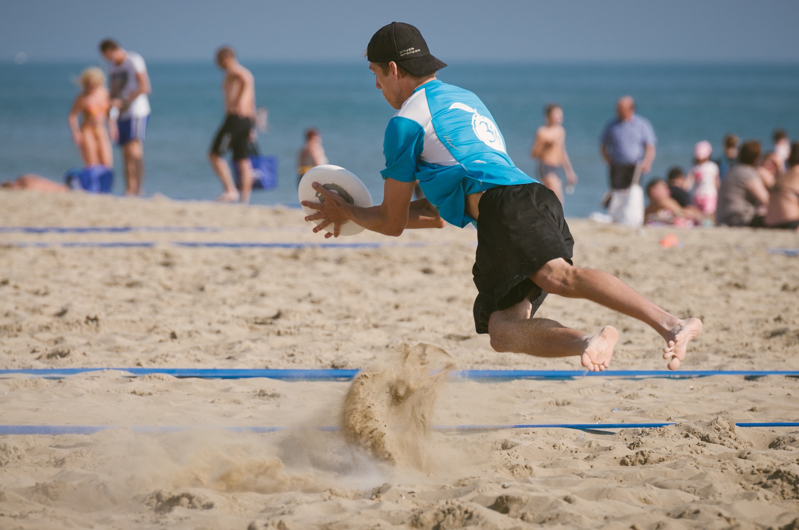 Man catch Frisbee on Sand Beach free image download