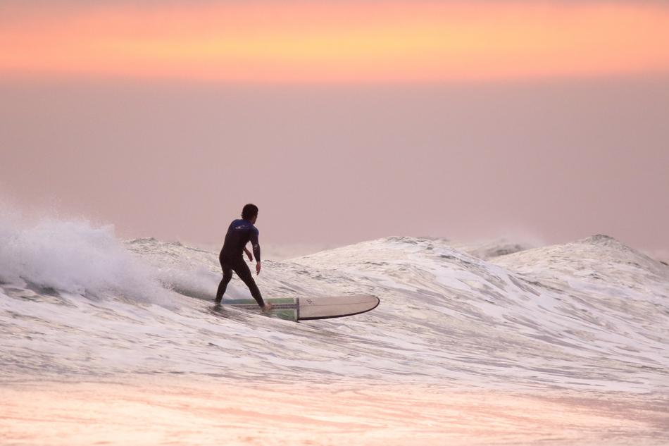 Surfer on wave at Sunset free image download